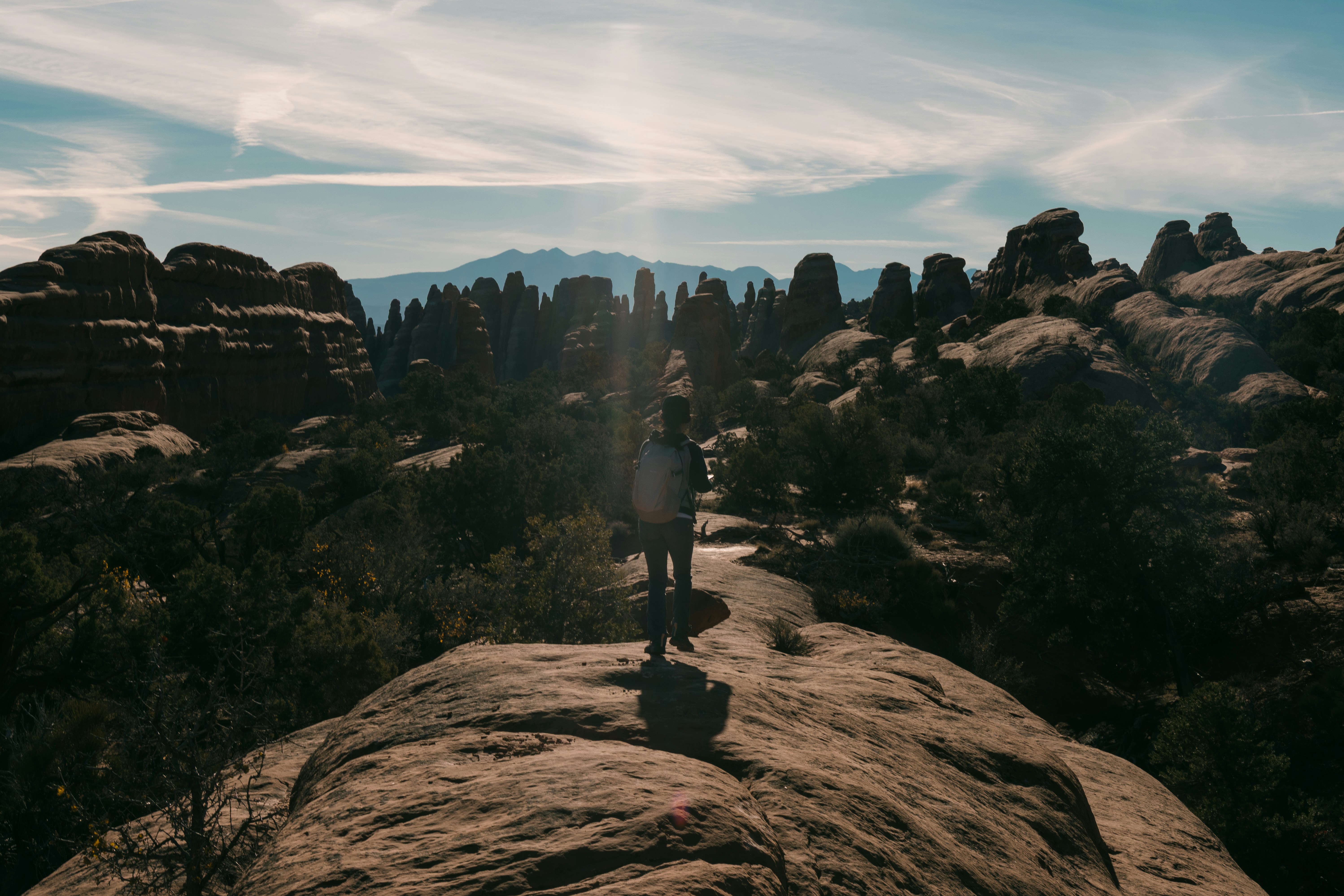 Edgewalker on a Granite Promontory Amid Desert Spires