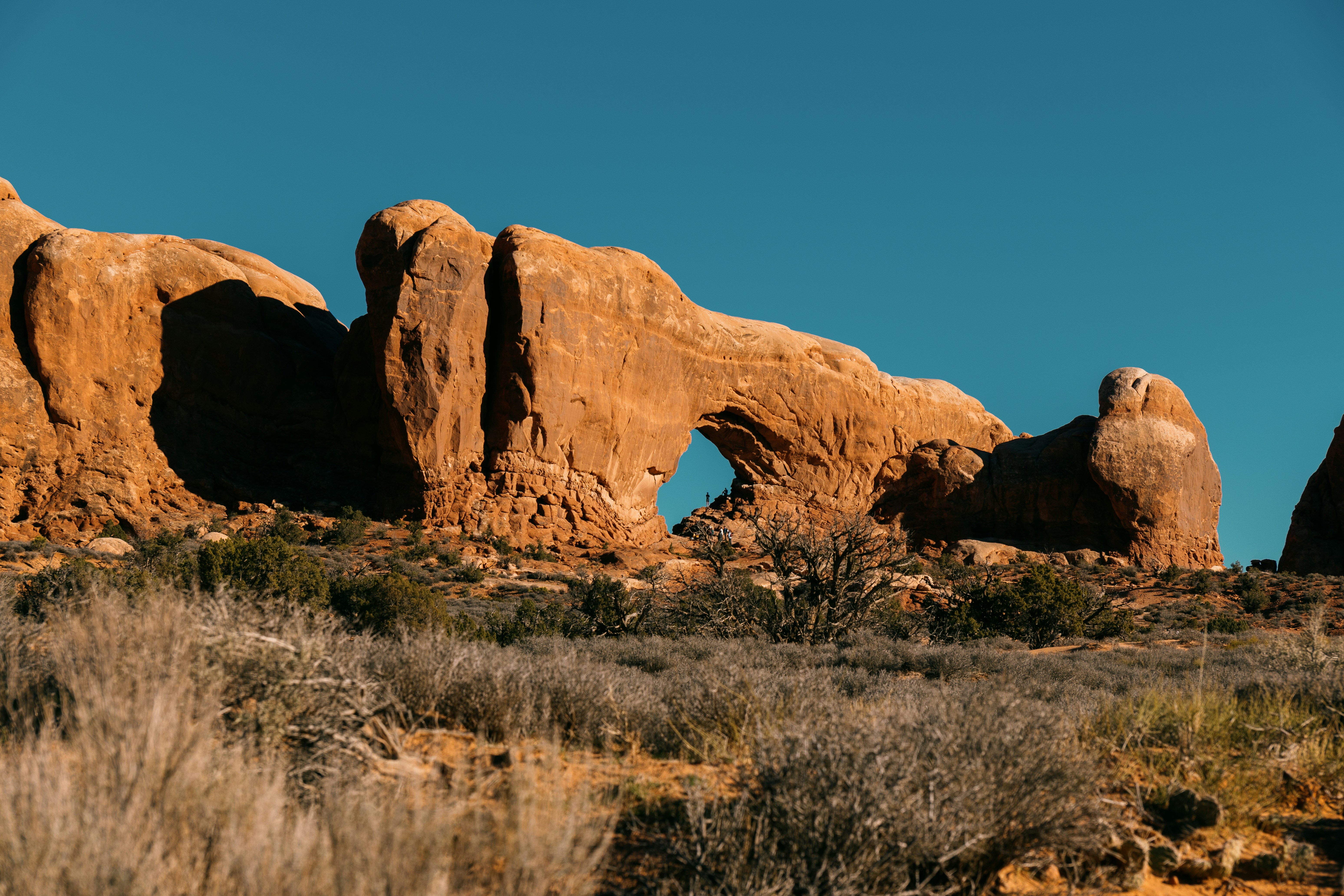 Arch of Ember Rock: Desert Window Framed by a Cerulean Sky