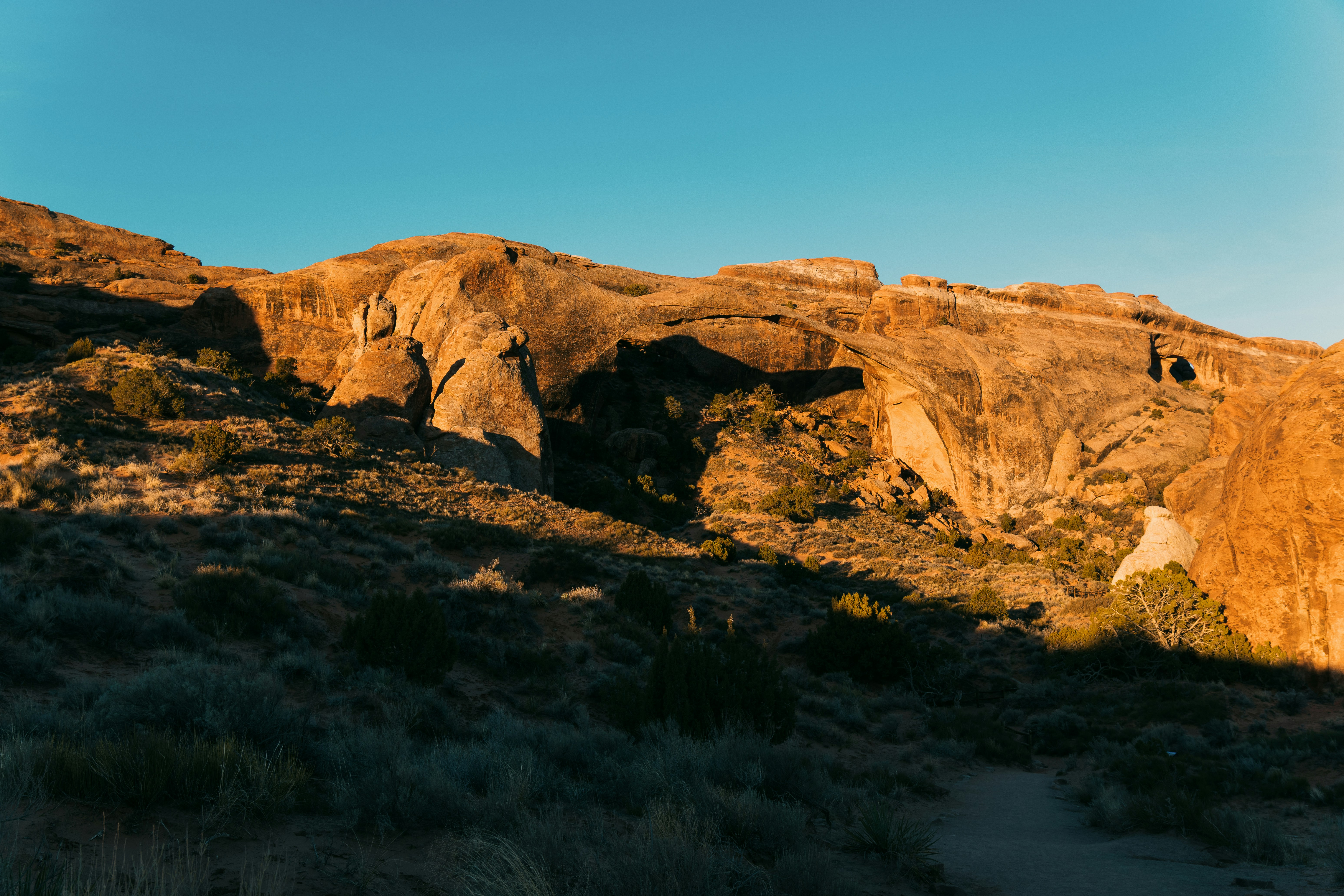 Ridges of Fire and Sky: A Desert Cliffscape at Golden Hour