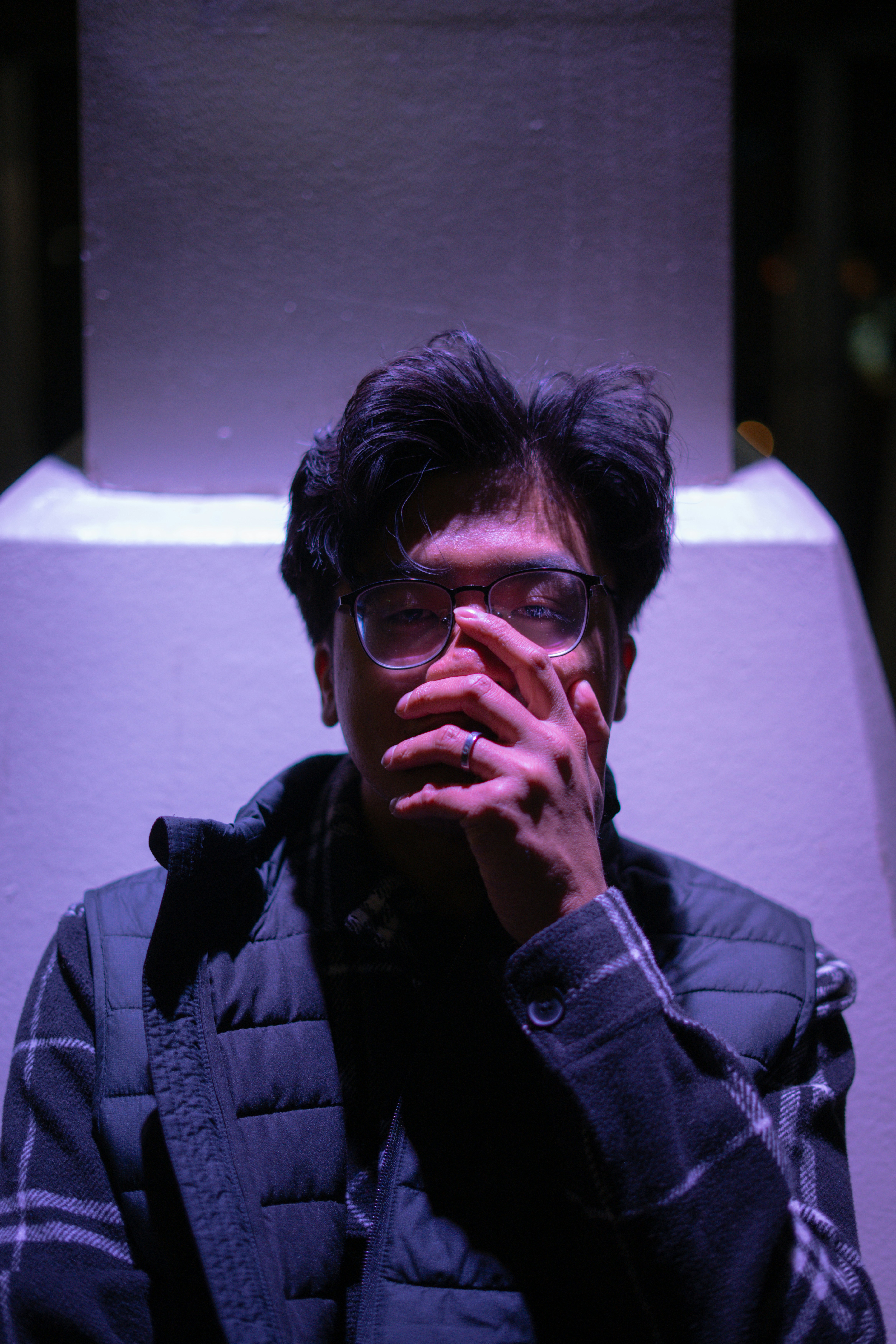 Violet Quiet: Contemplative Portrait Framed by a Neon-Blue Pillar