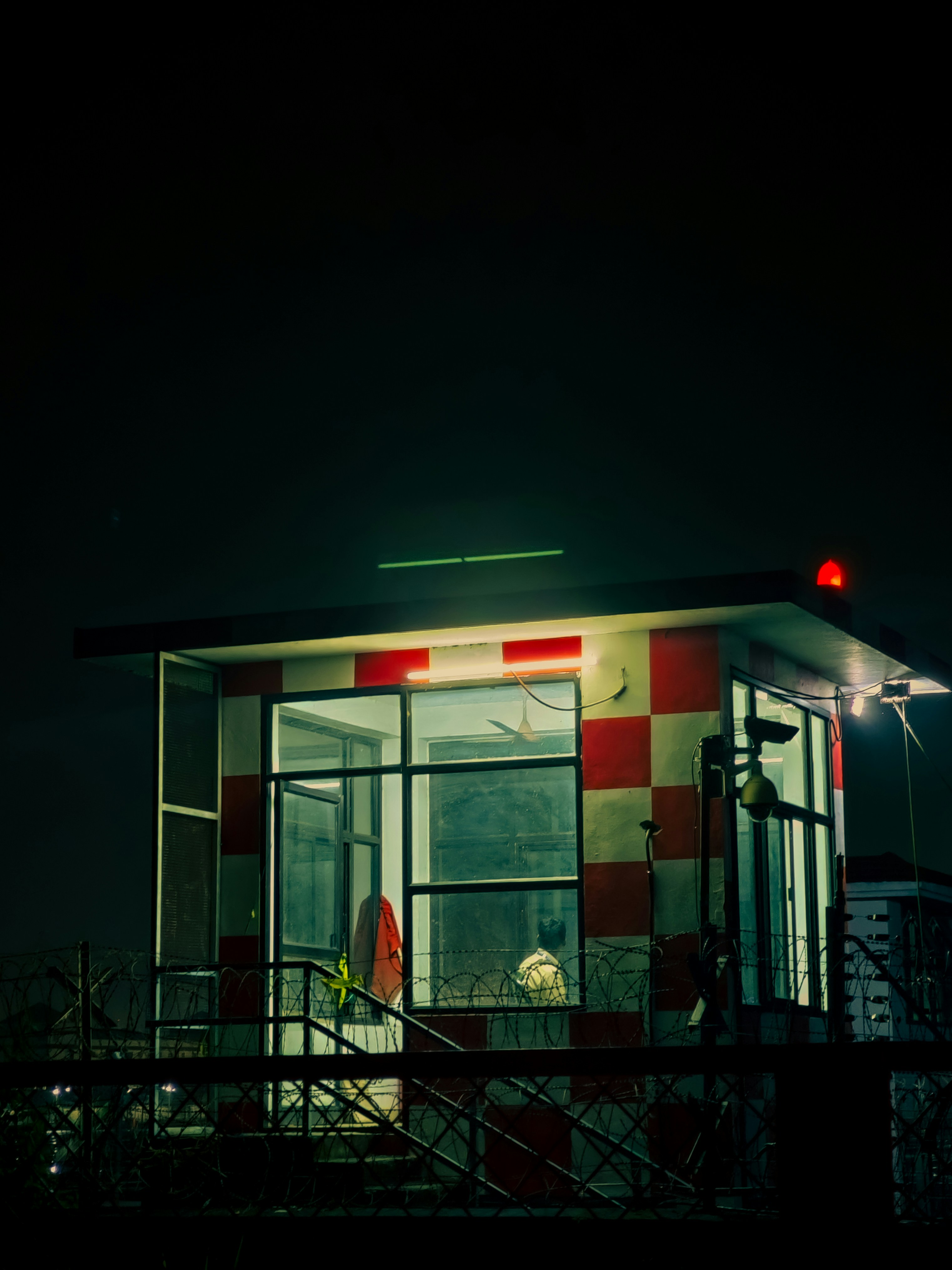 Guarded by Neon: Night Shift at a Checkerboard Kiosk
