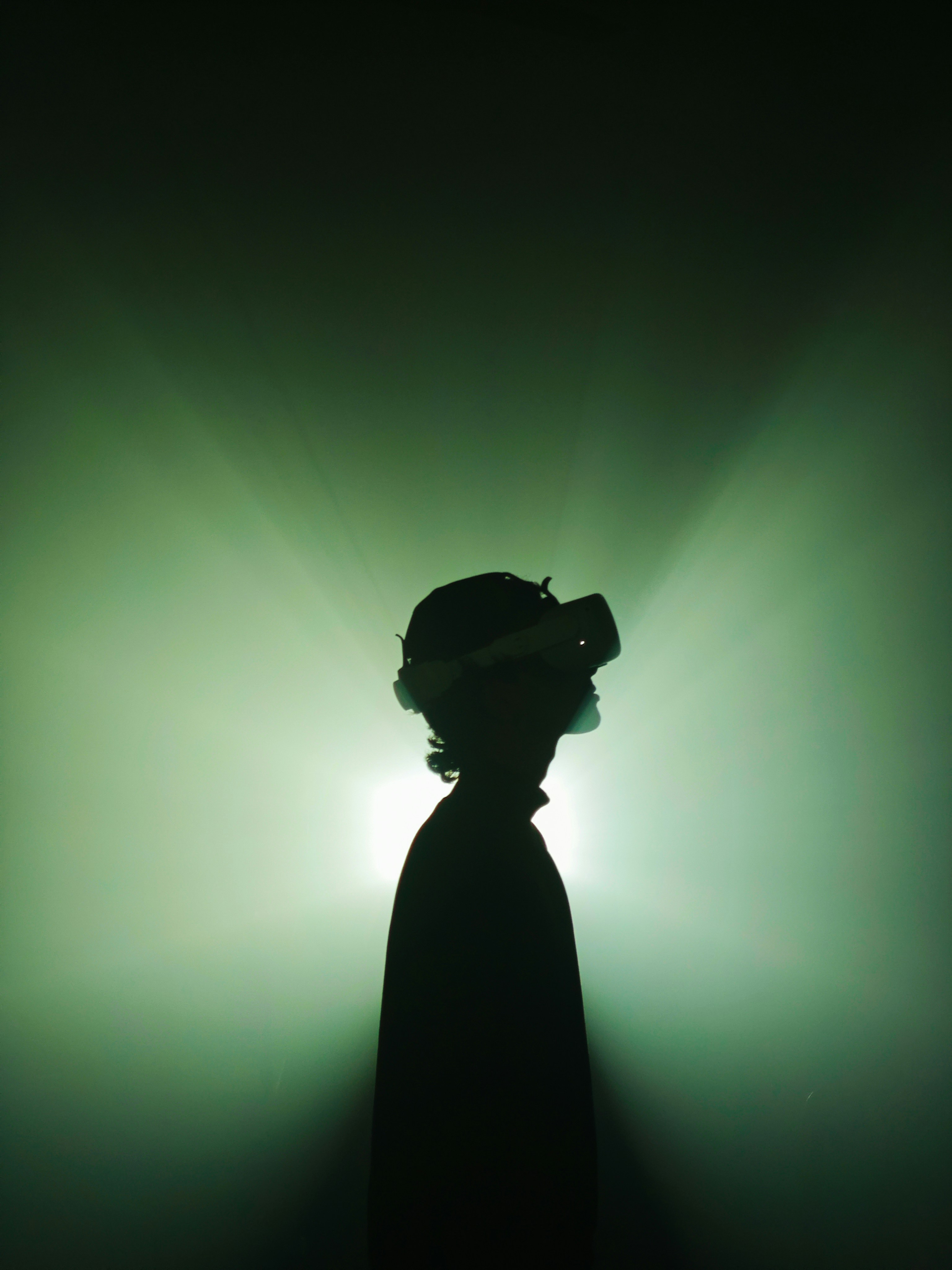 Haloed silhouette: a figure in backlit green haze