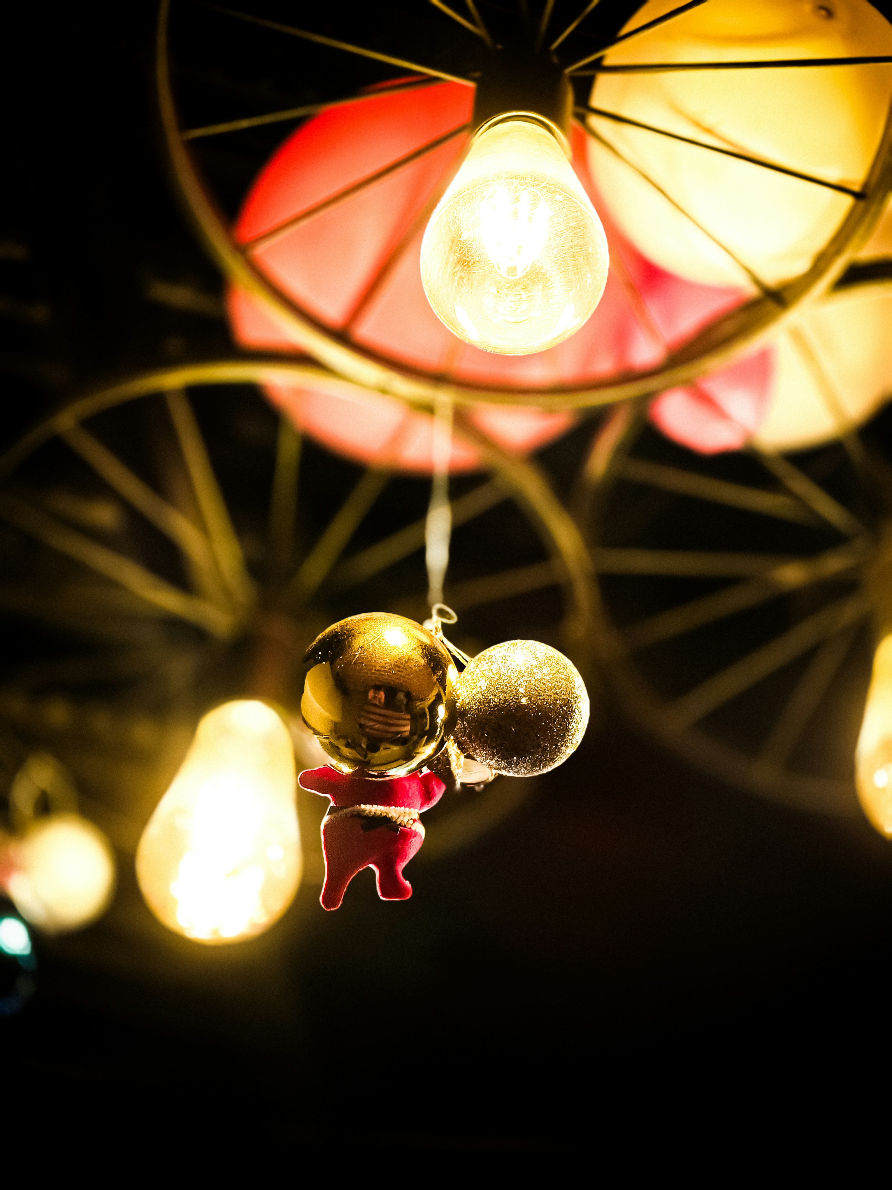Hanging Ornament Duo Beneath a Glowing Bulb