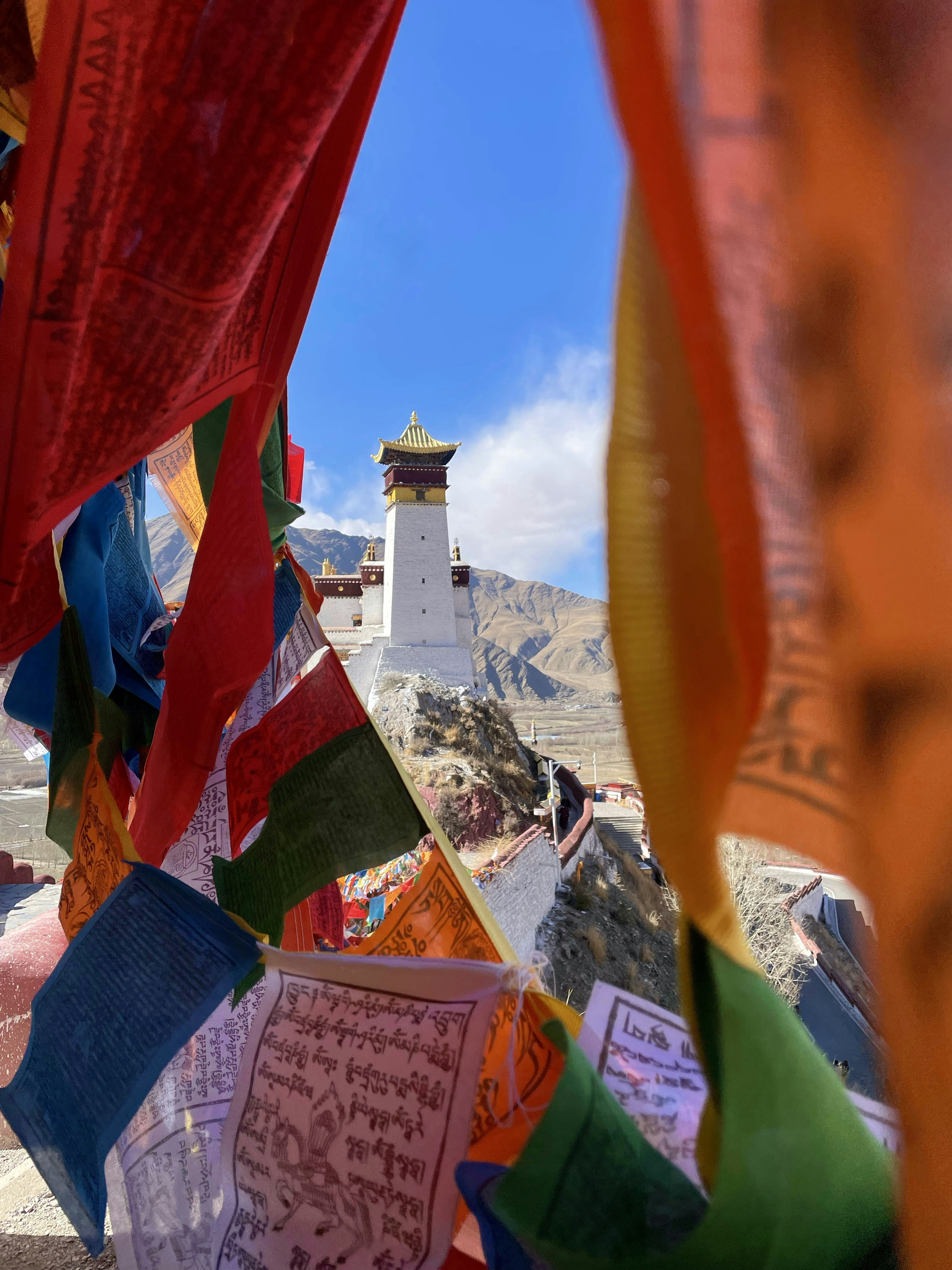 Between Prayer Flags, a Mountain Stupa Emerges