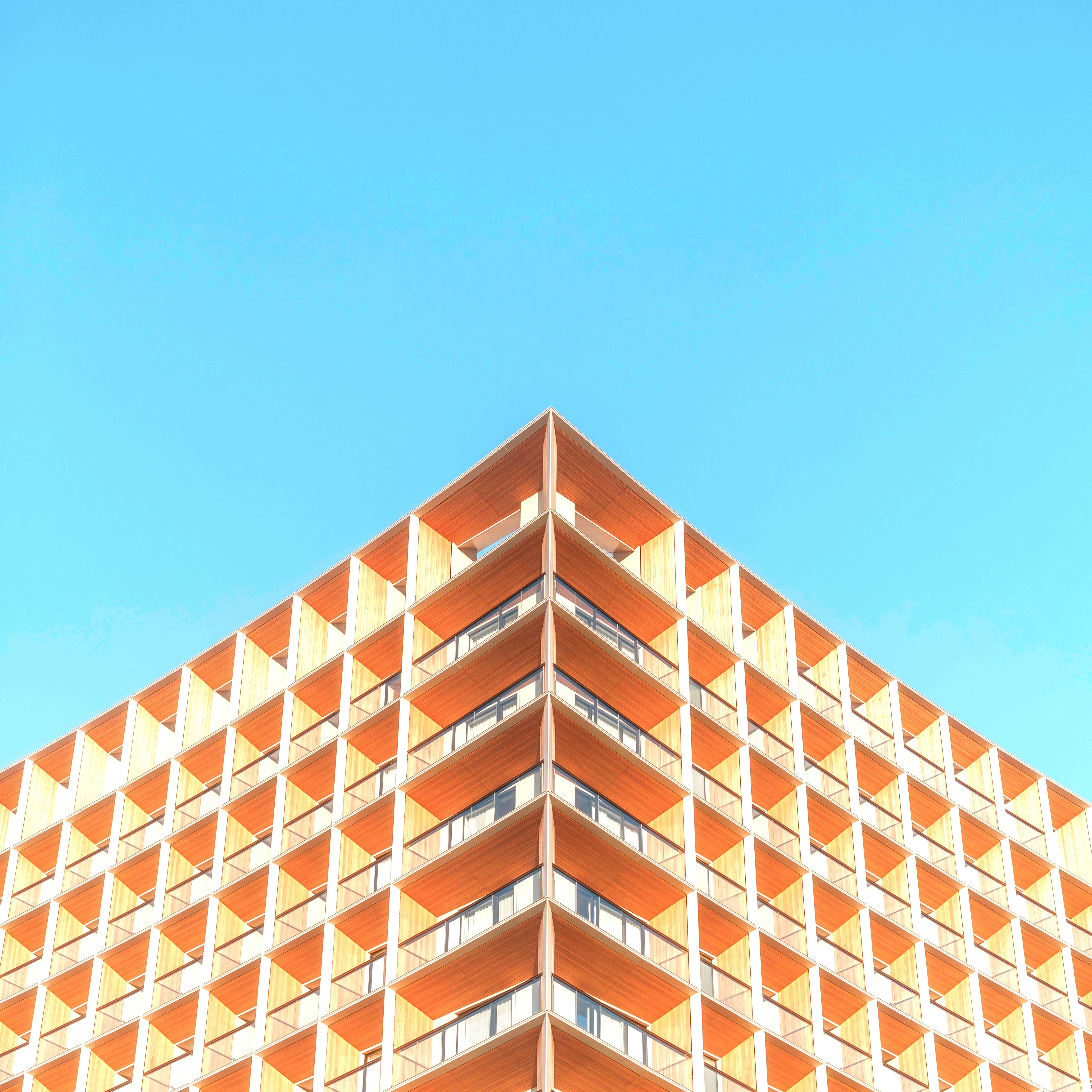 Corner Prism: Repeating Balconies under a Clear Sky