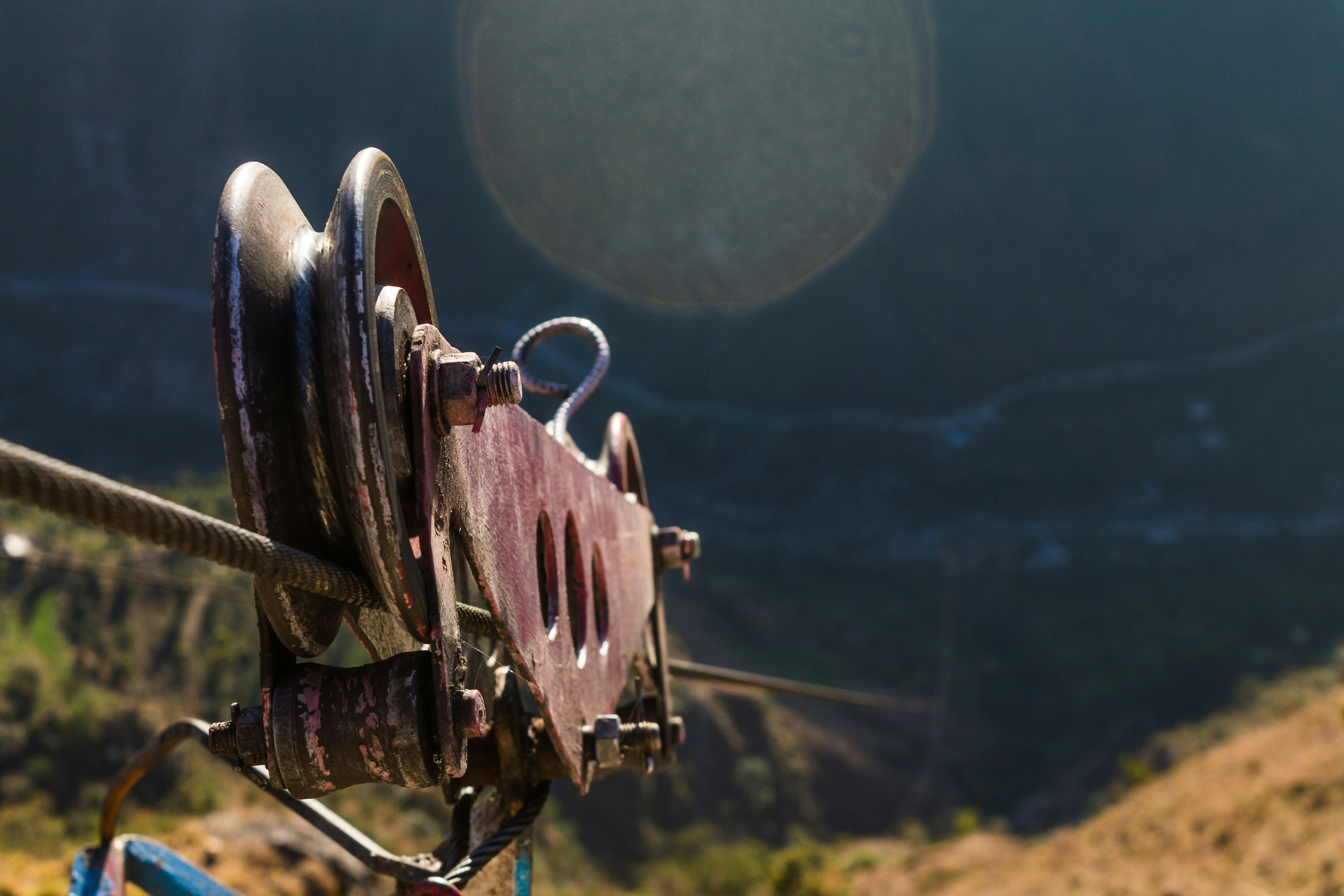 Rusted Winch in Alpine Backlight: A Close-Up of Weathered Gear