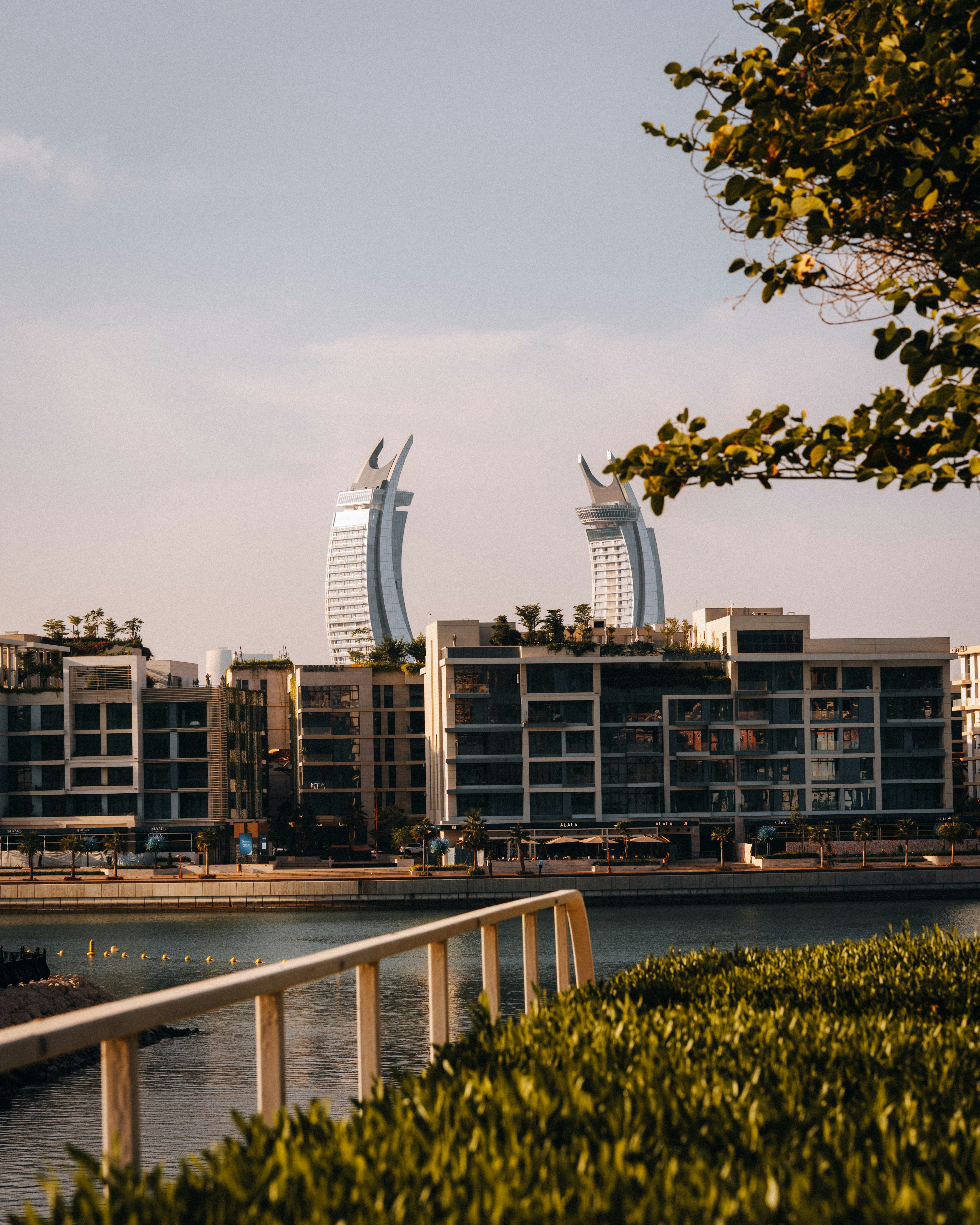Twin Sail Towers Framing a Quiet Marina