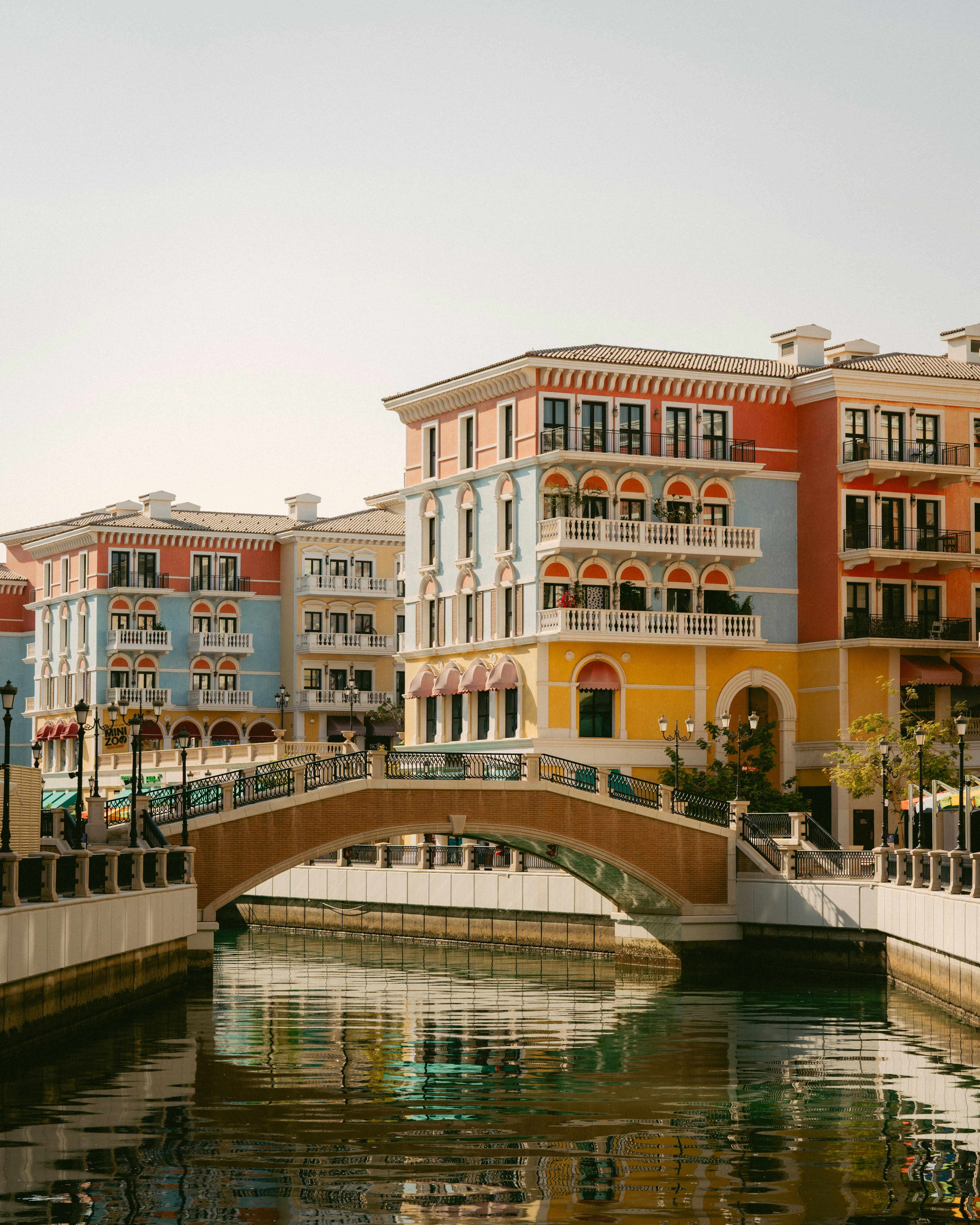 Pastel Arcades Over a Sunlit Canal