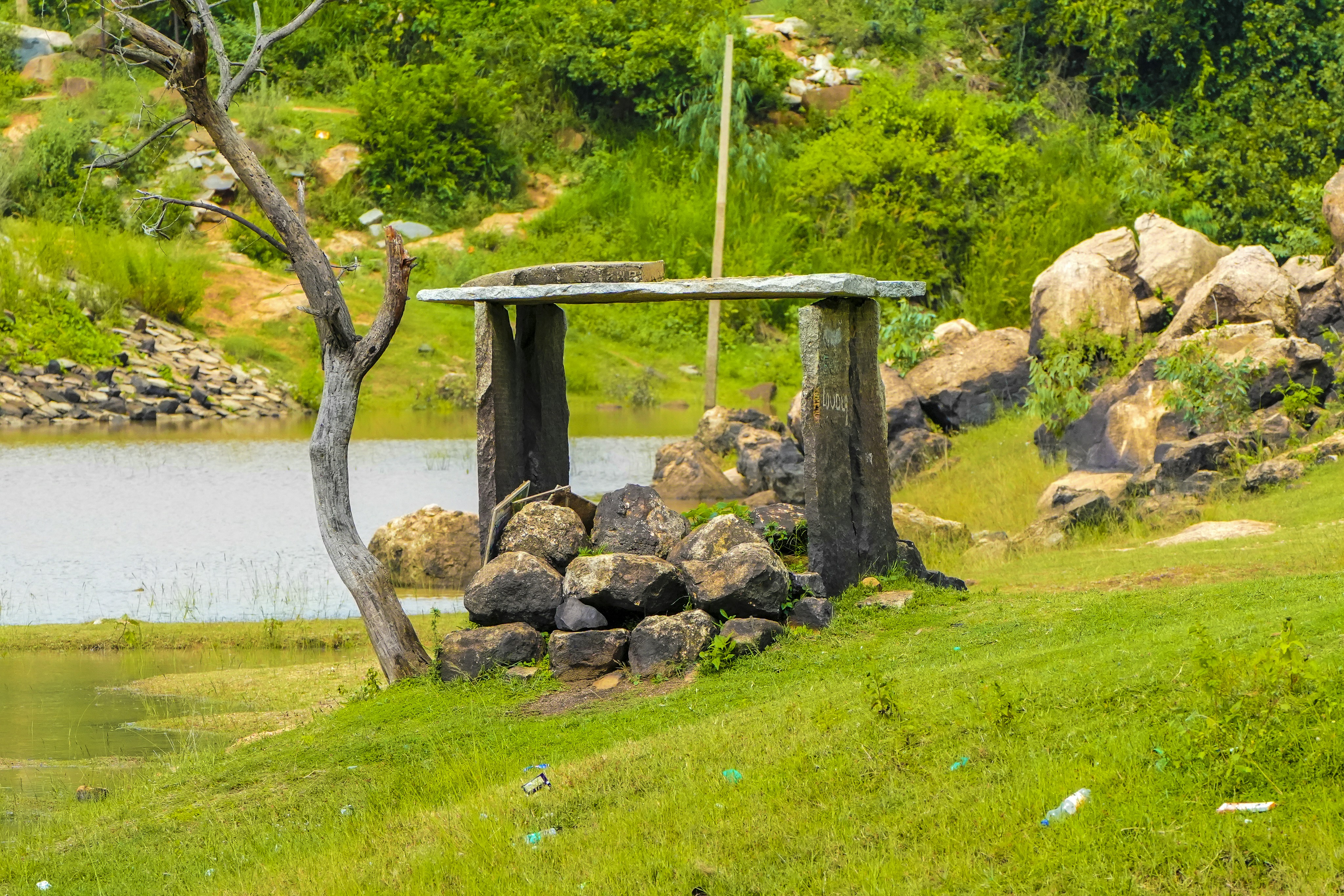 The Quiet Pavilion: Weathered Stone Shelter Framing a Serene Pond