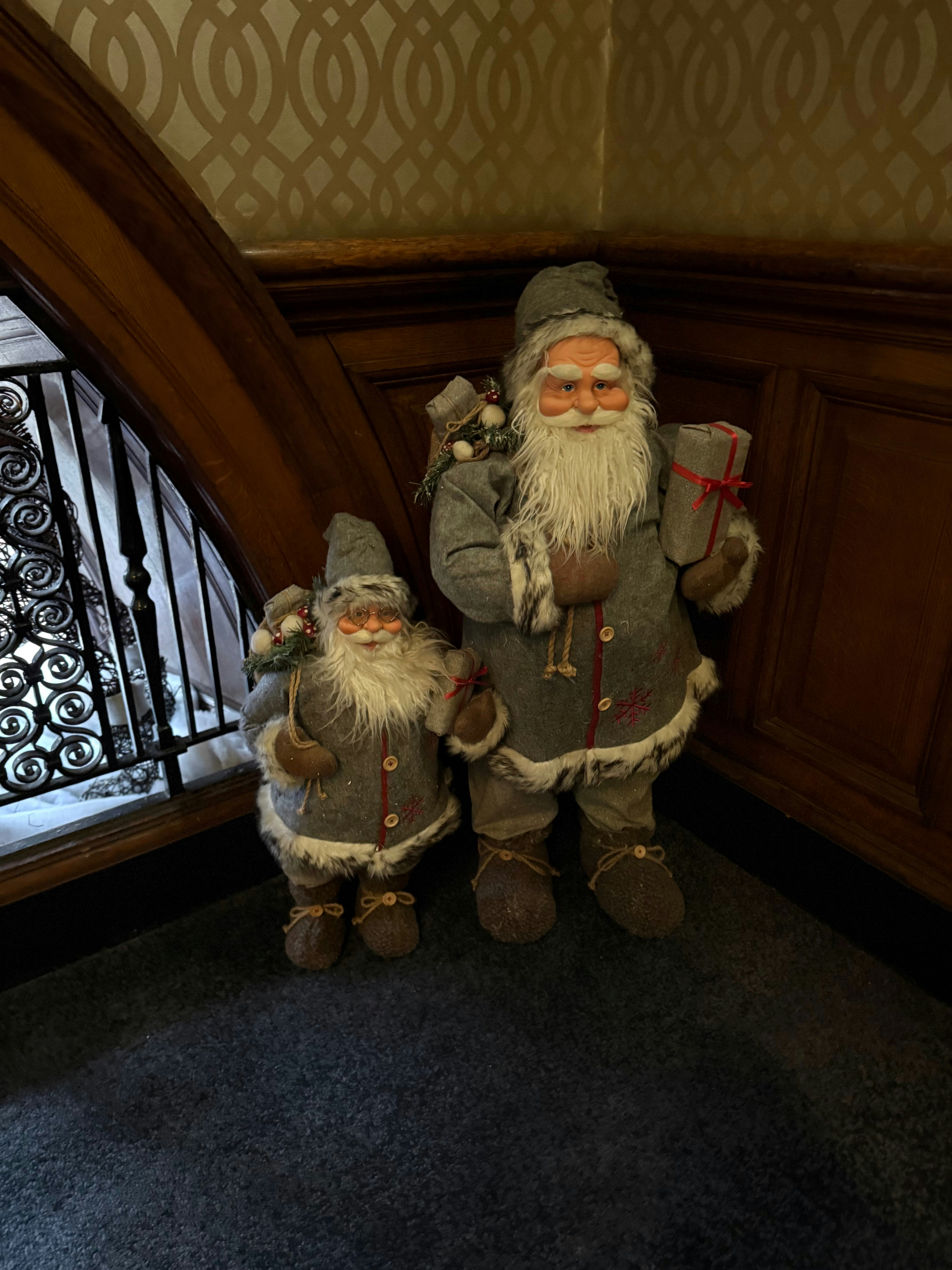 Twin Santa Sentinels in a Wood-Walled Corner