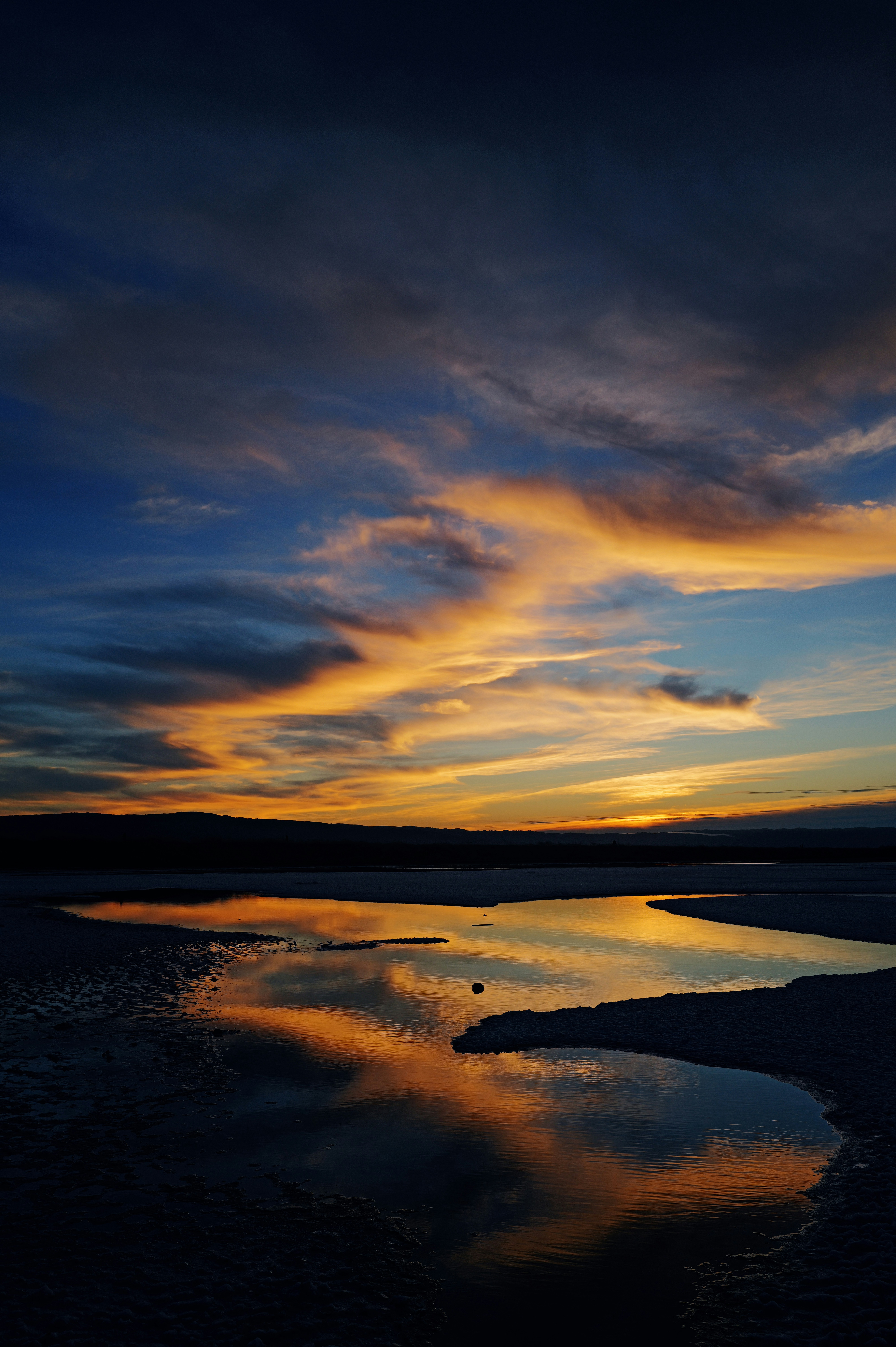 Fiery Ribbon over a Quiet Salt Flat at Dusk