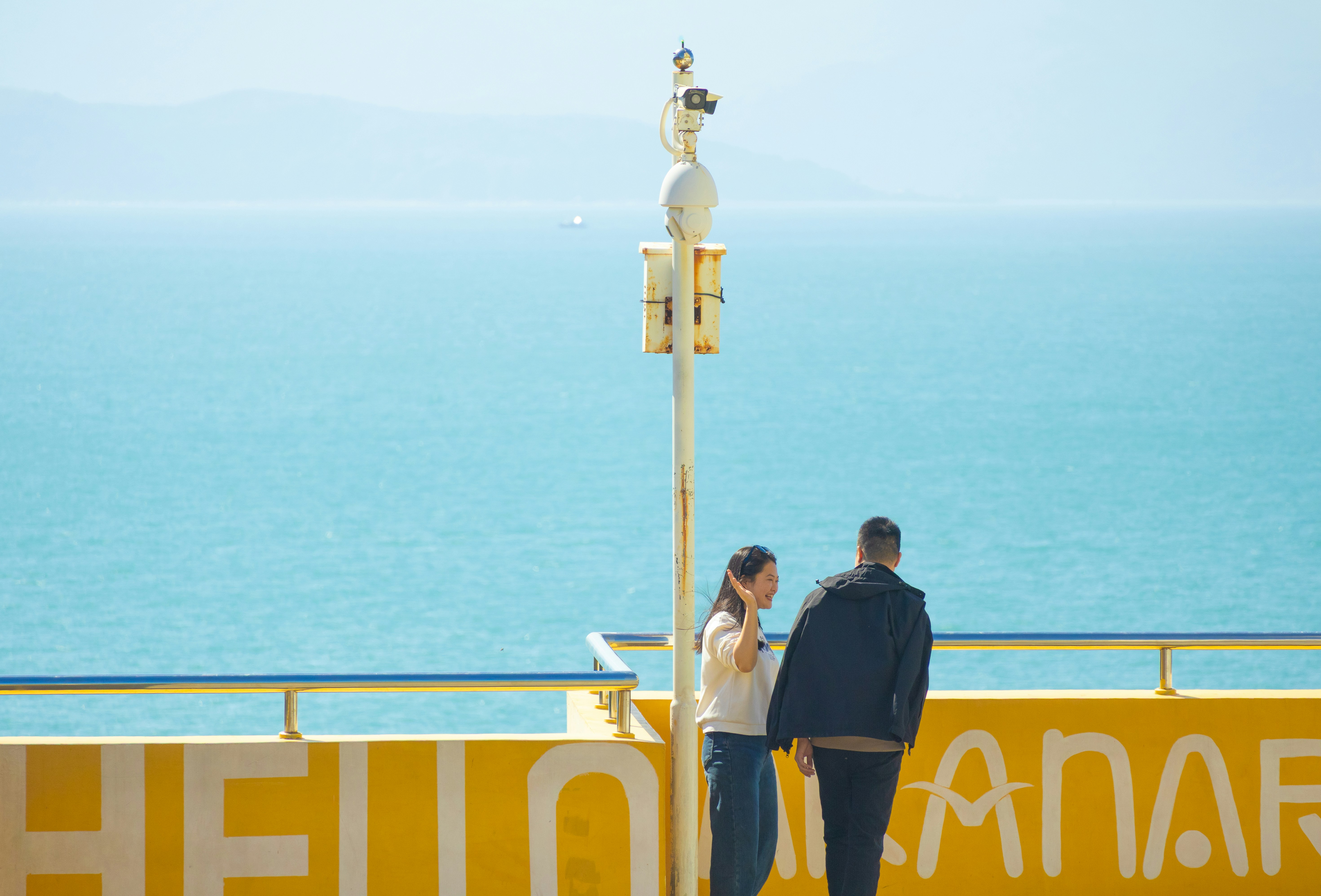 Sunlit Exchange by the Turquoise Sea Promenade