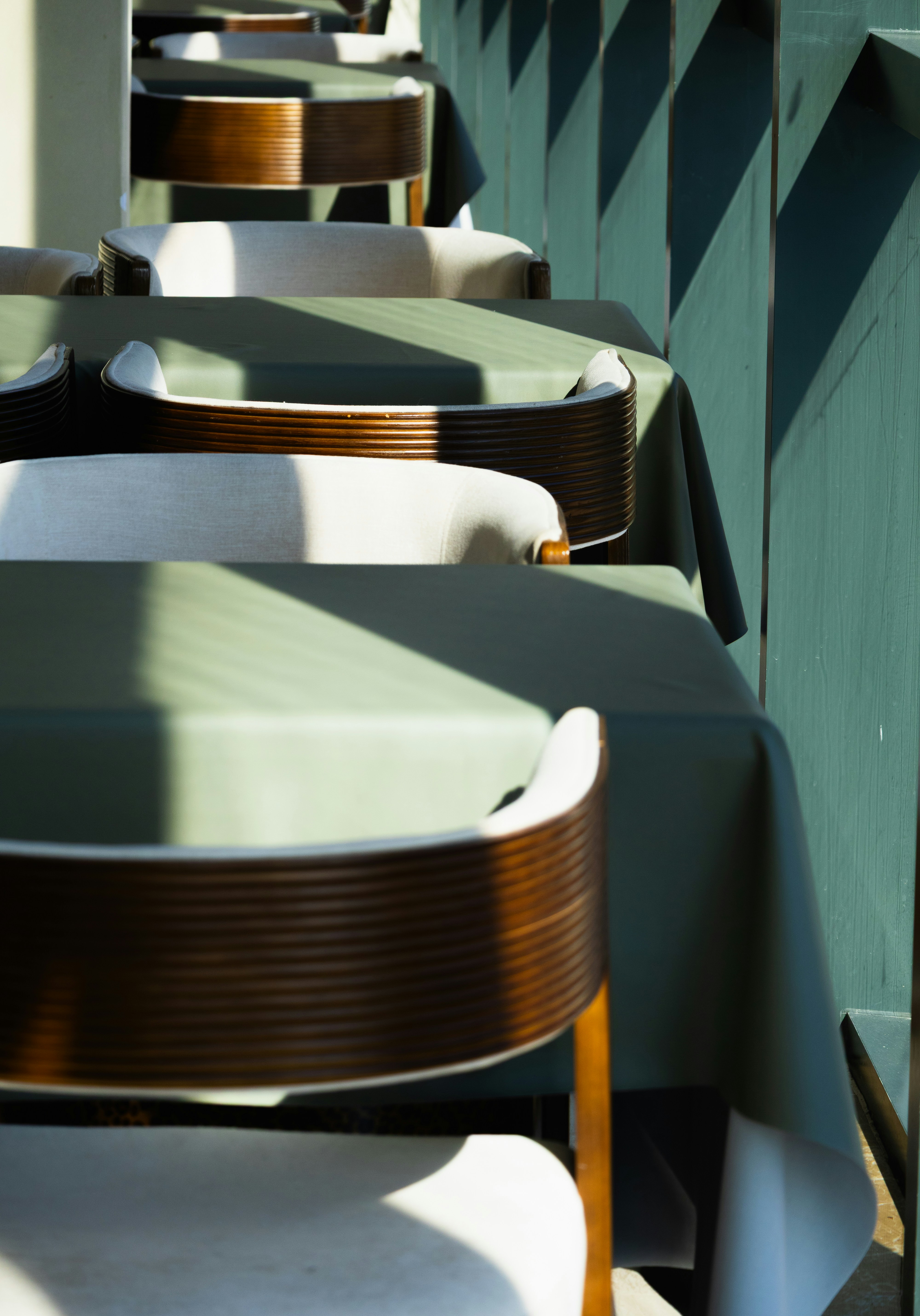 Green Tablecloth Geometry Along a Teal Terrace