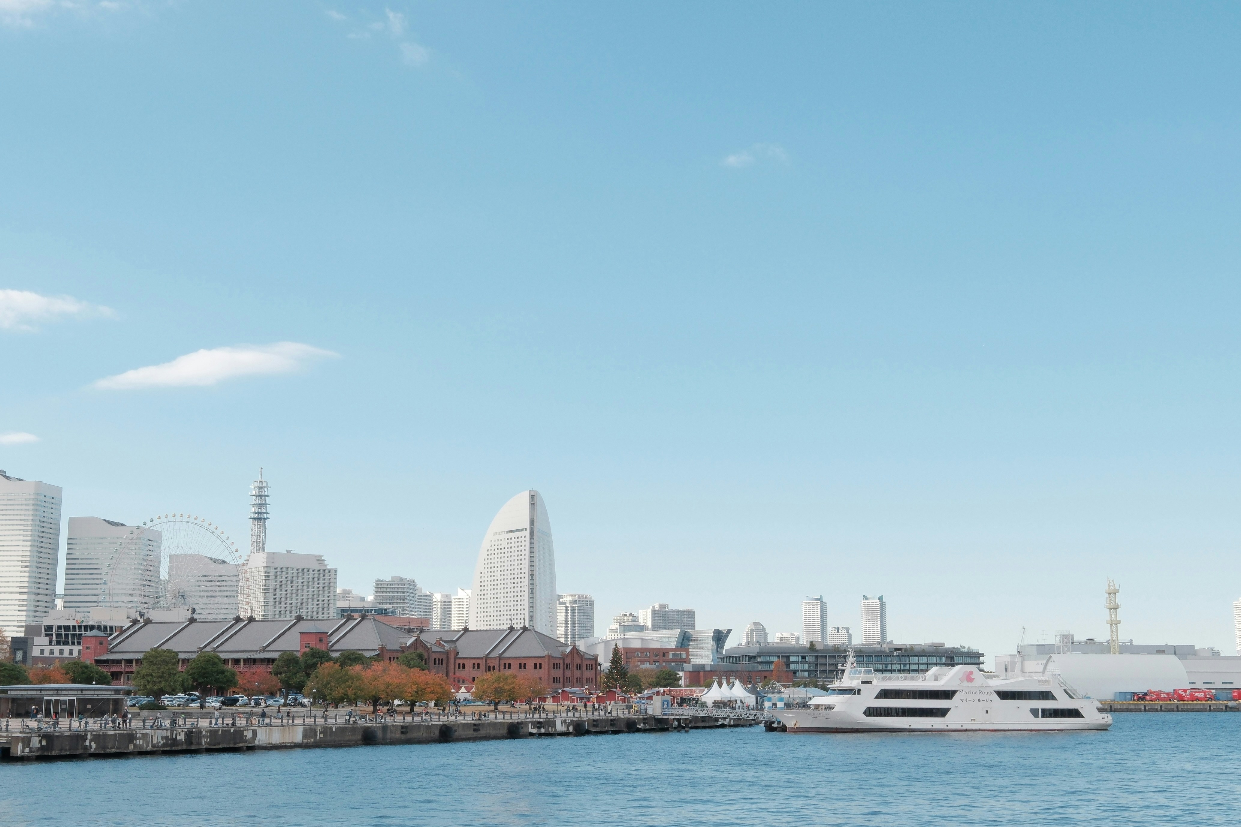 Harbor Silhouettes: A Docked White Yacht Against a Modern Skyline