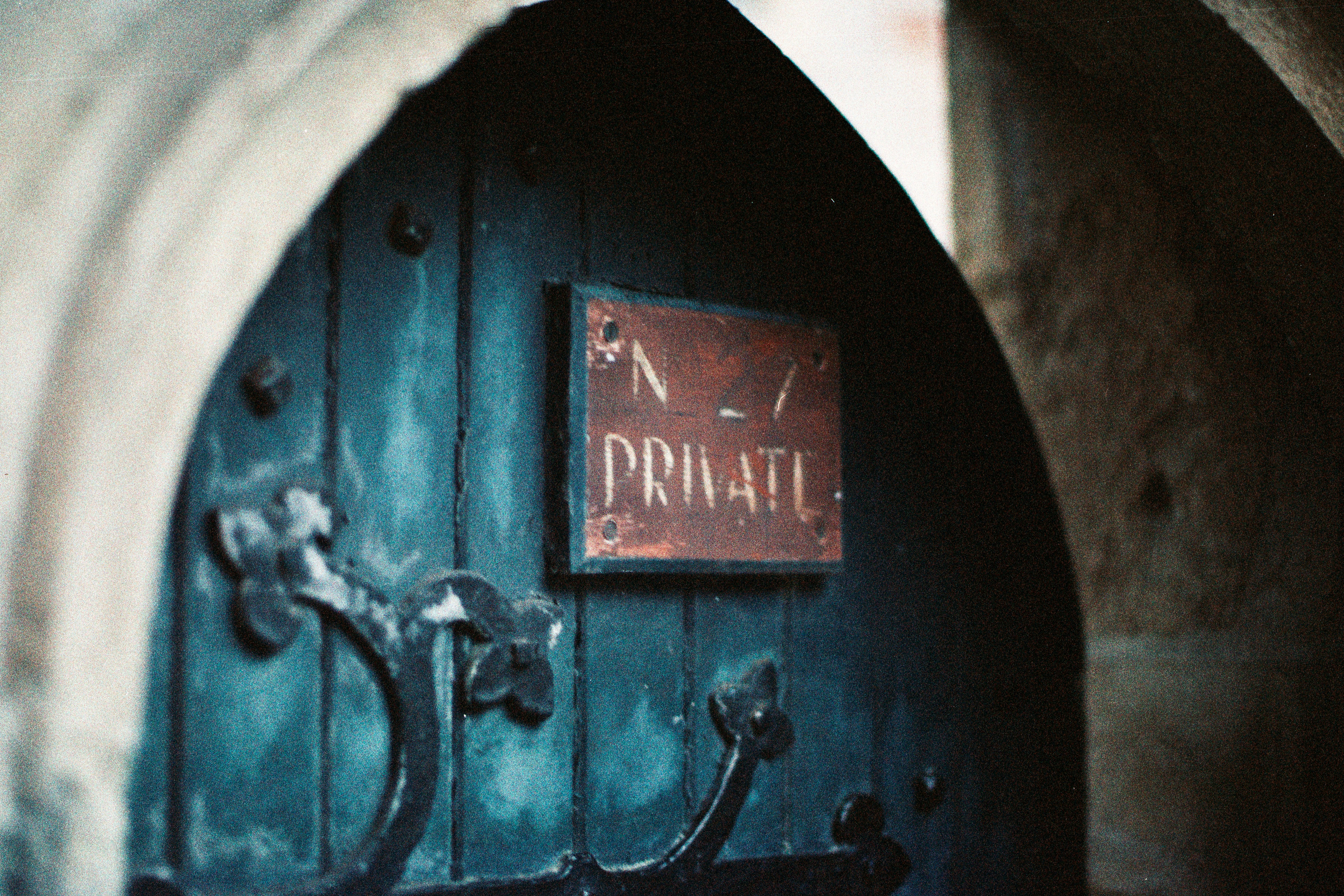 Private Plaque in a Shadowed Arched Doorway