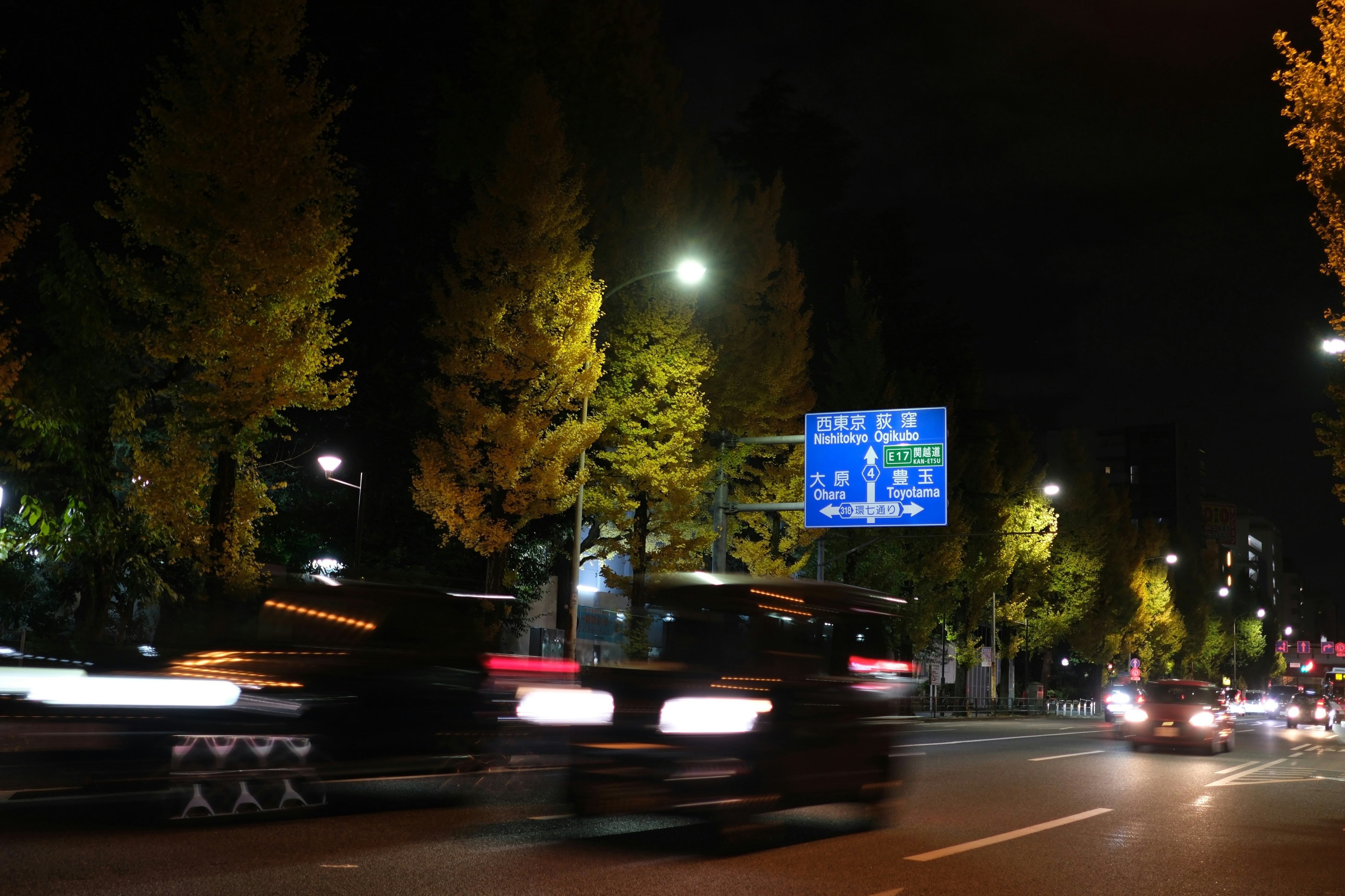 Blue Highway Sign amid Neon Motion: Night Street Blur