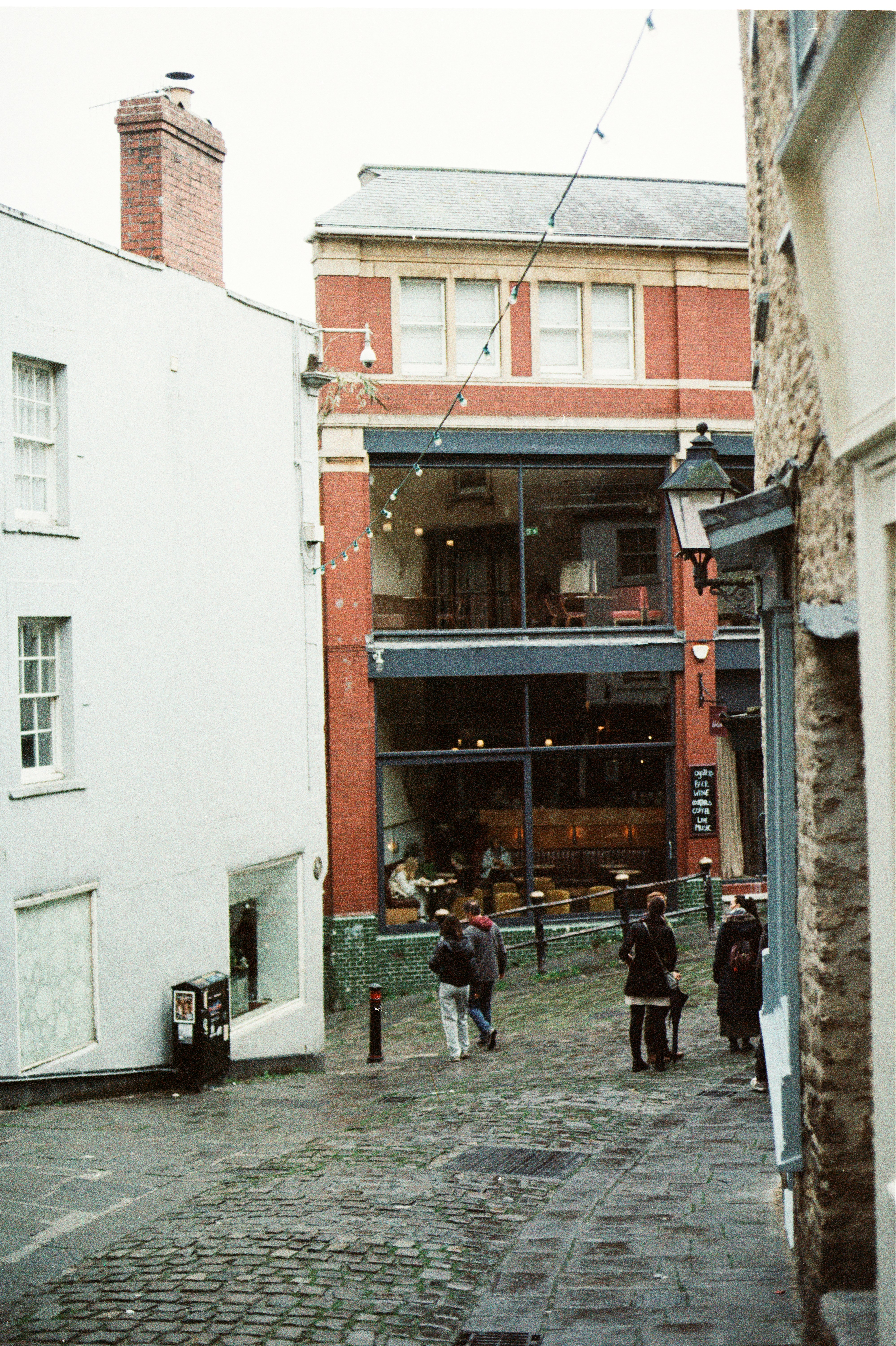 Brick-Faced Café at the End of a Cobblestone Alley