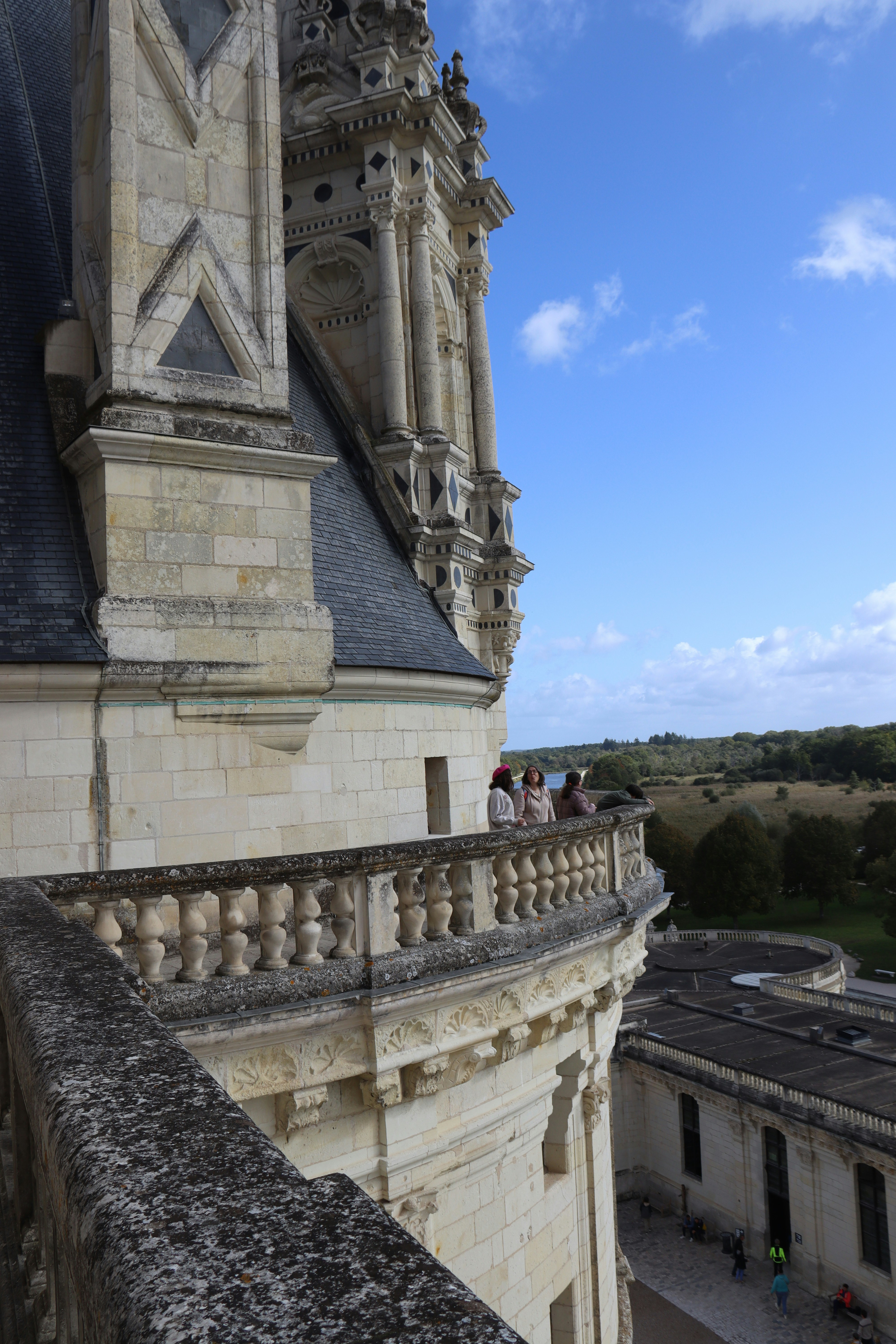 Stone Turret Balcony: Visitors Gaze Over a Rolling Landscape