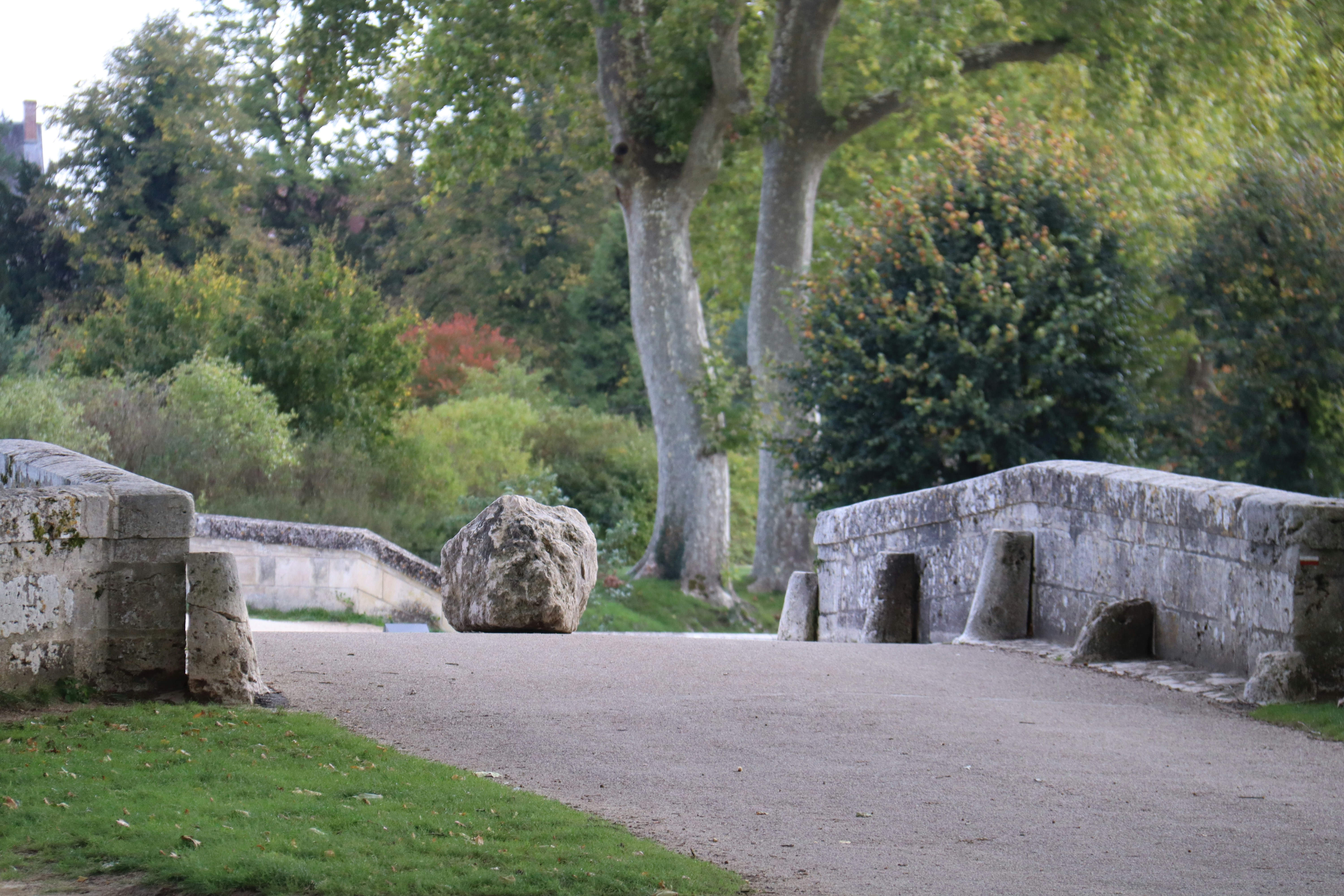 Stone bridge arching over a pathway in a park photo – Free Architecture ...