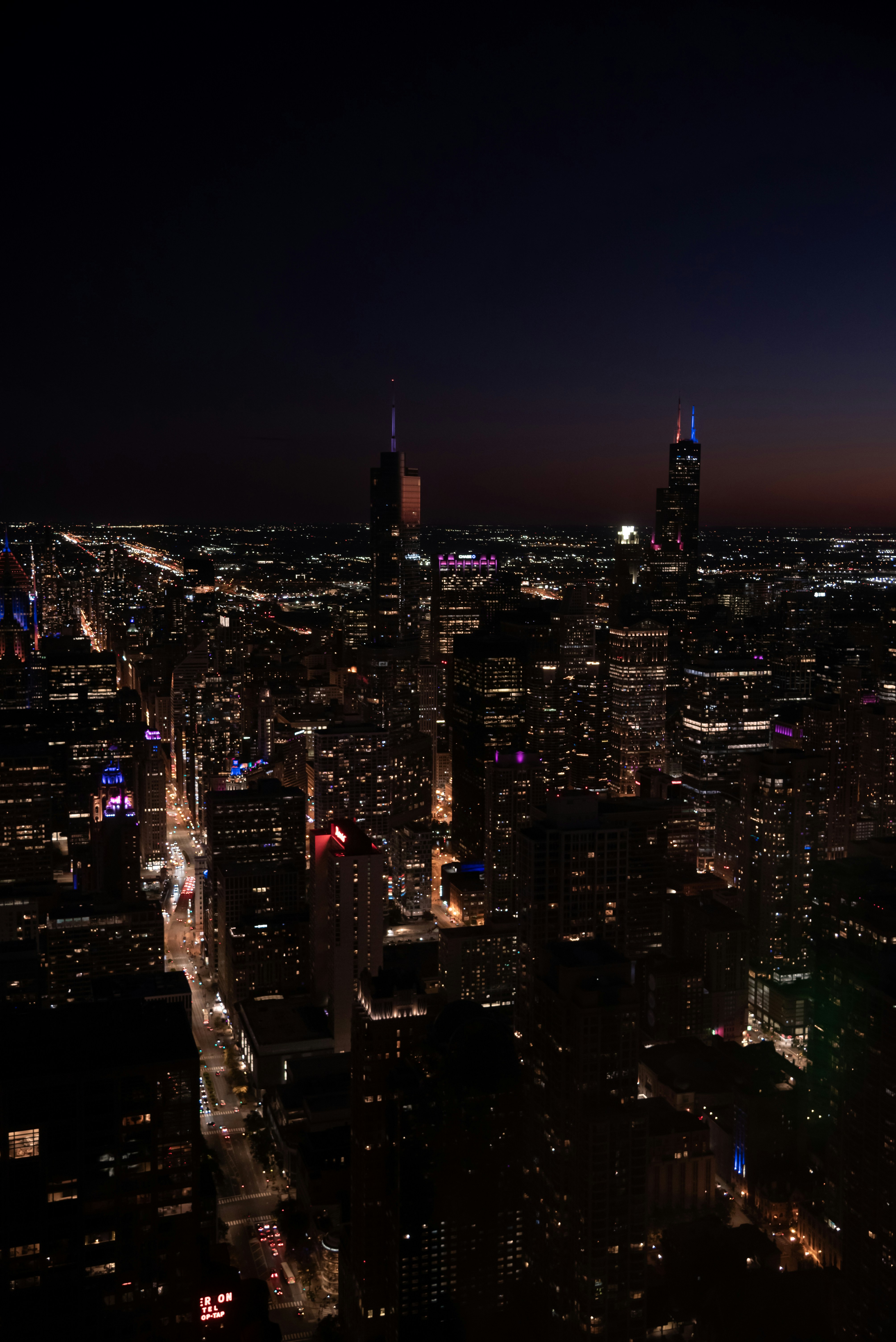 View of Chicago skyline after the sun sets. View of Sears (Willis) Tower, Trump Tower, and Michigan Ave.