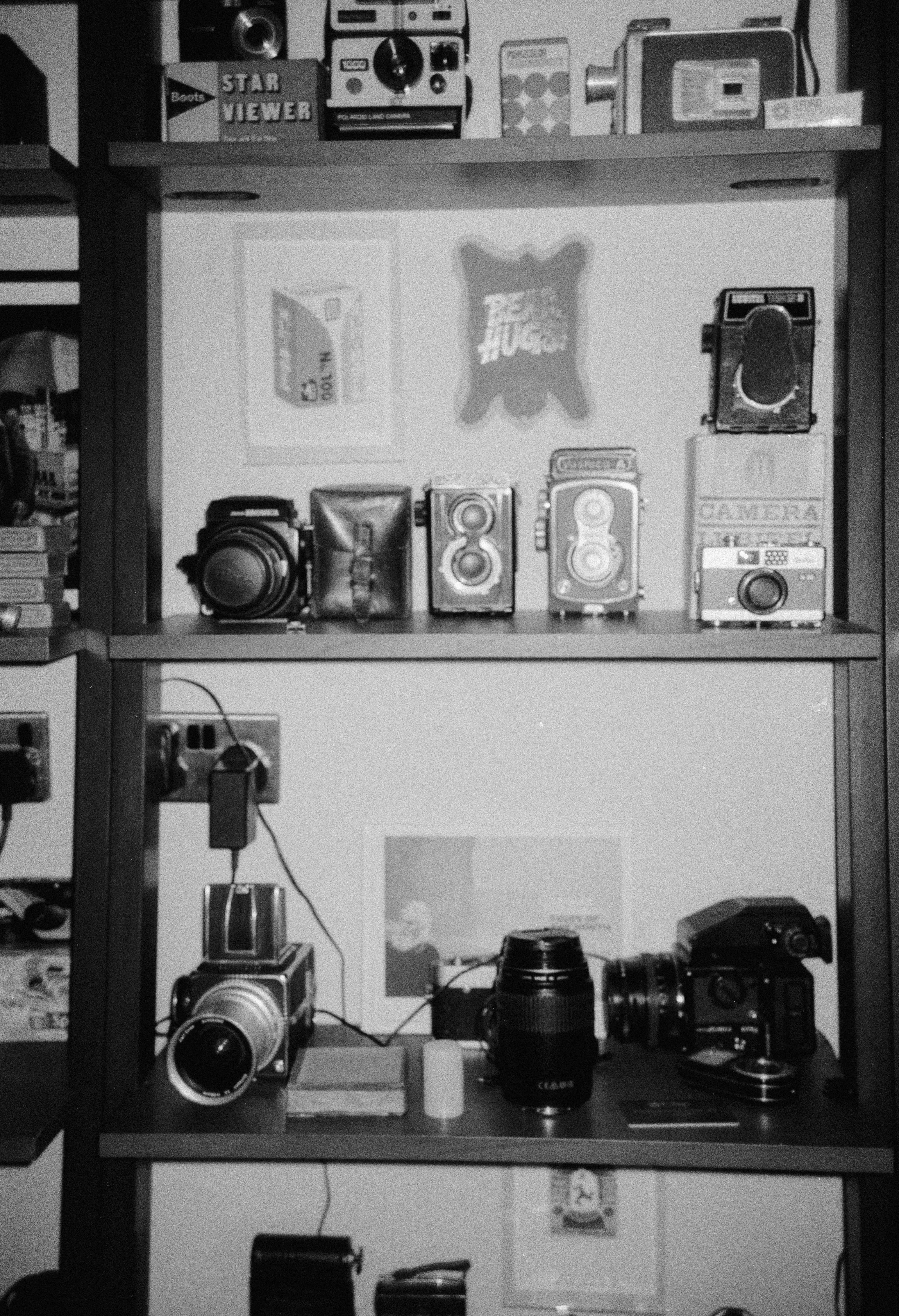 Collection of vintage cameras displayed on shelves