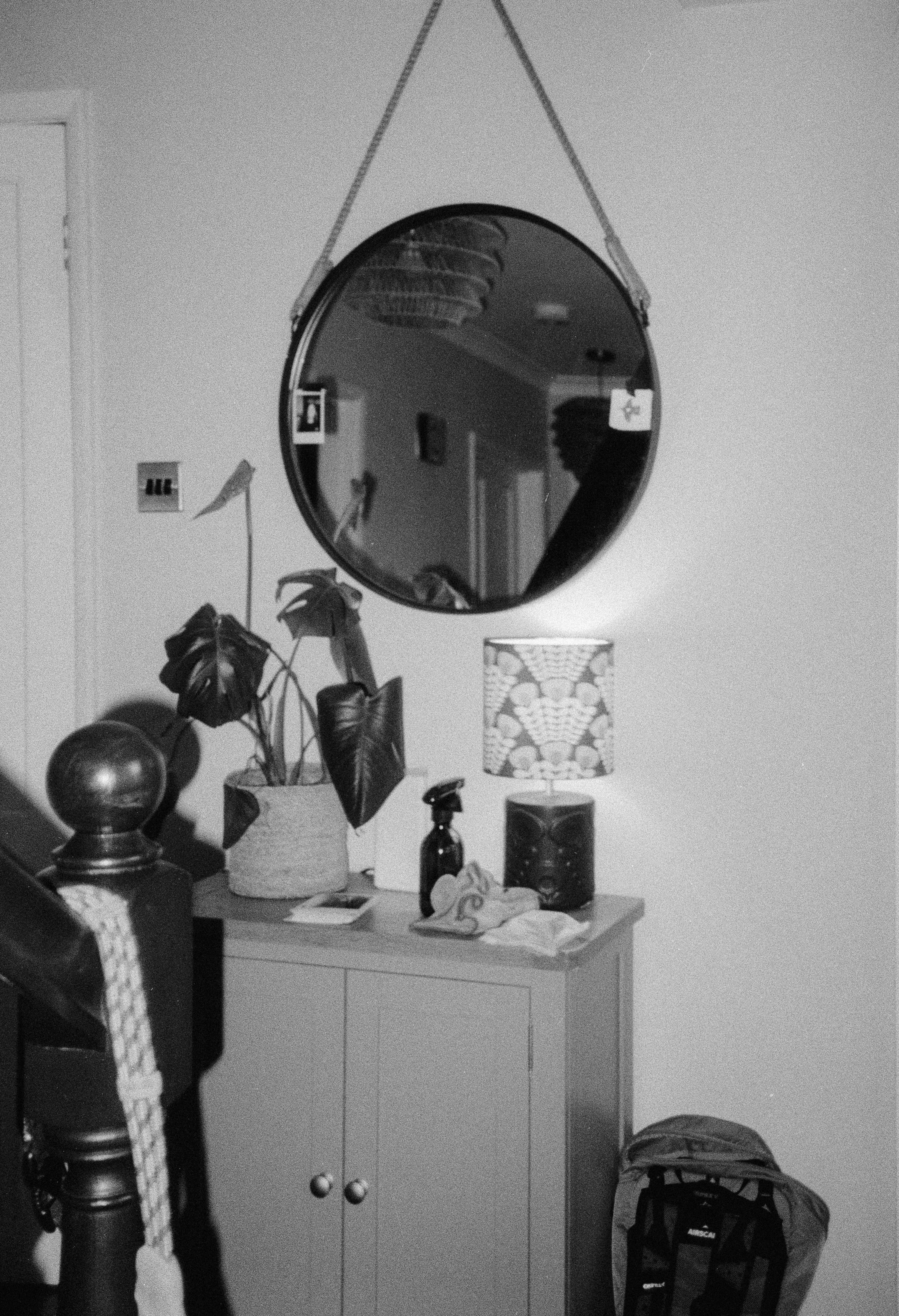 Round Mirror Reverie: A Quiet Hallway in Monochrome