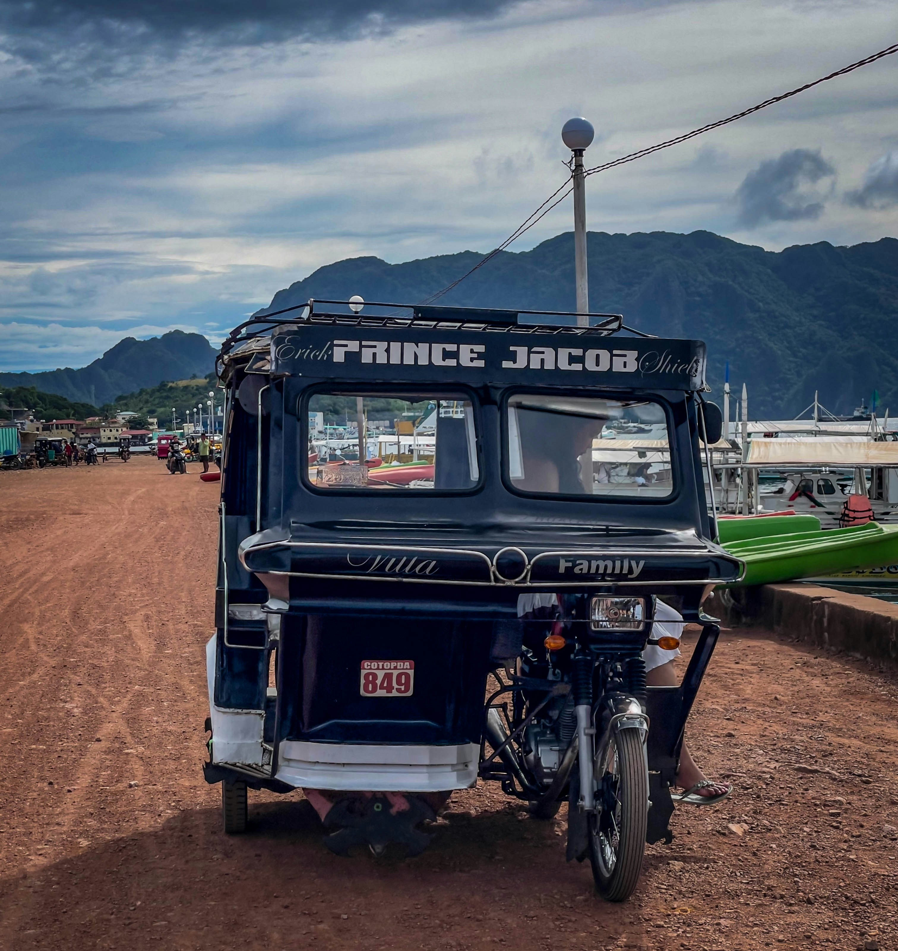 Prince Jacob's Blue Tuk-Tuk at the Harborfront, Mountain Backdrop