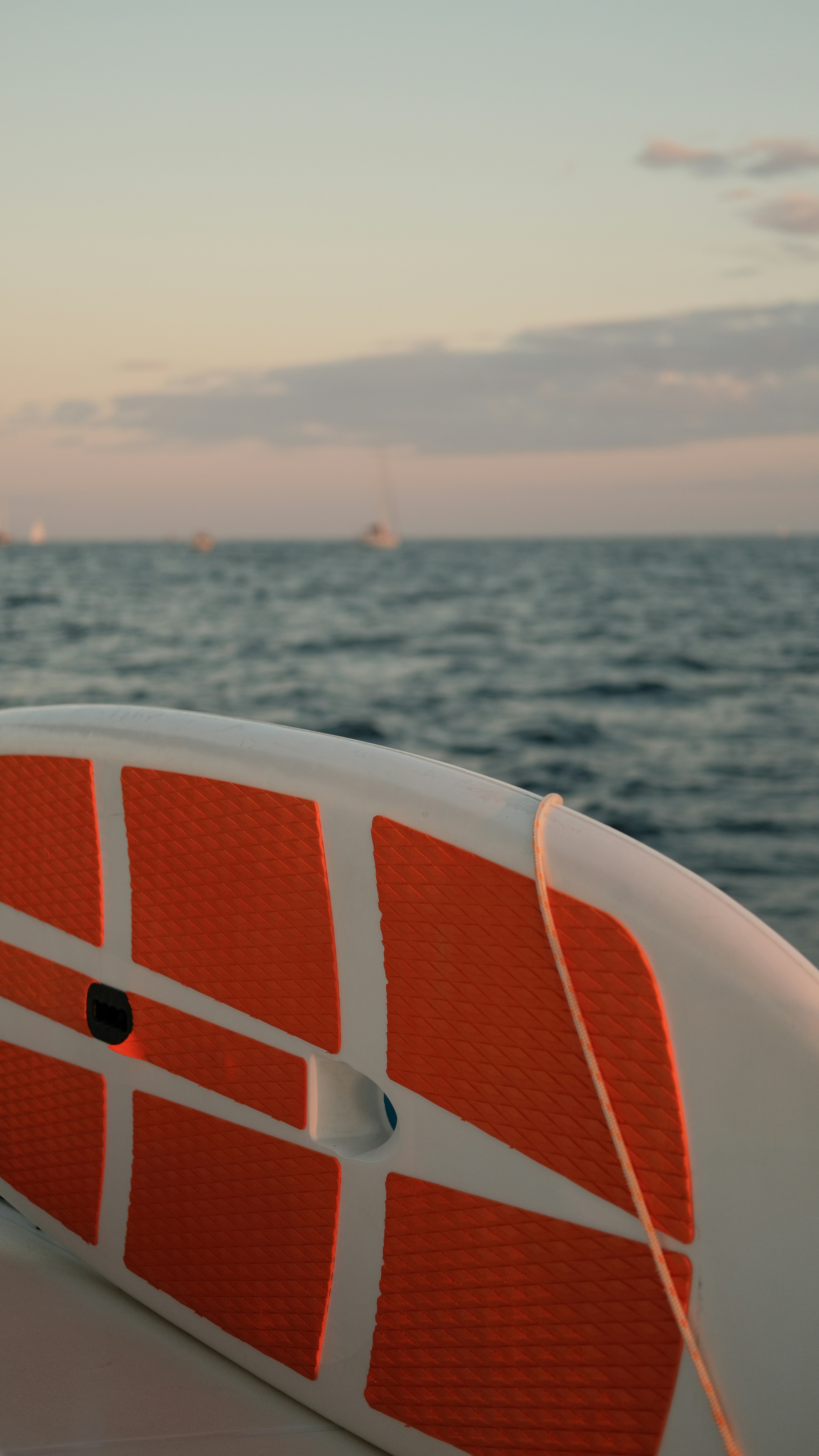 Dusk Deck: Sunset Light on Orange Surfboard Traction Pads