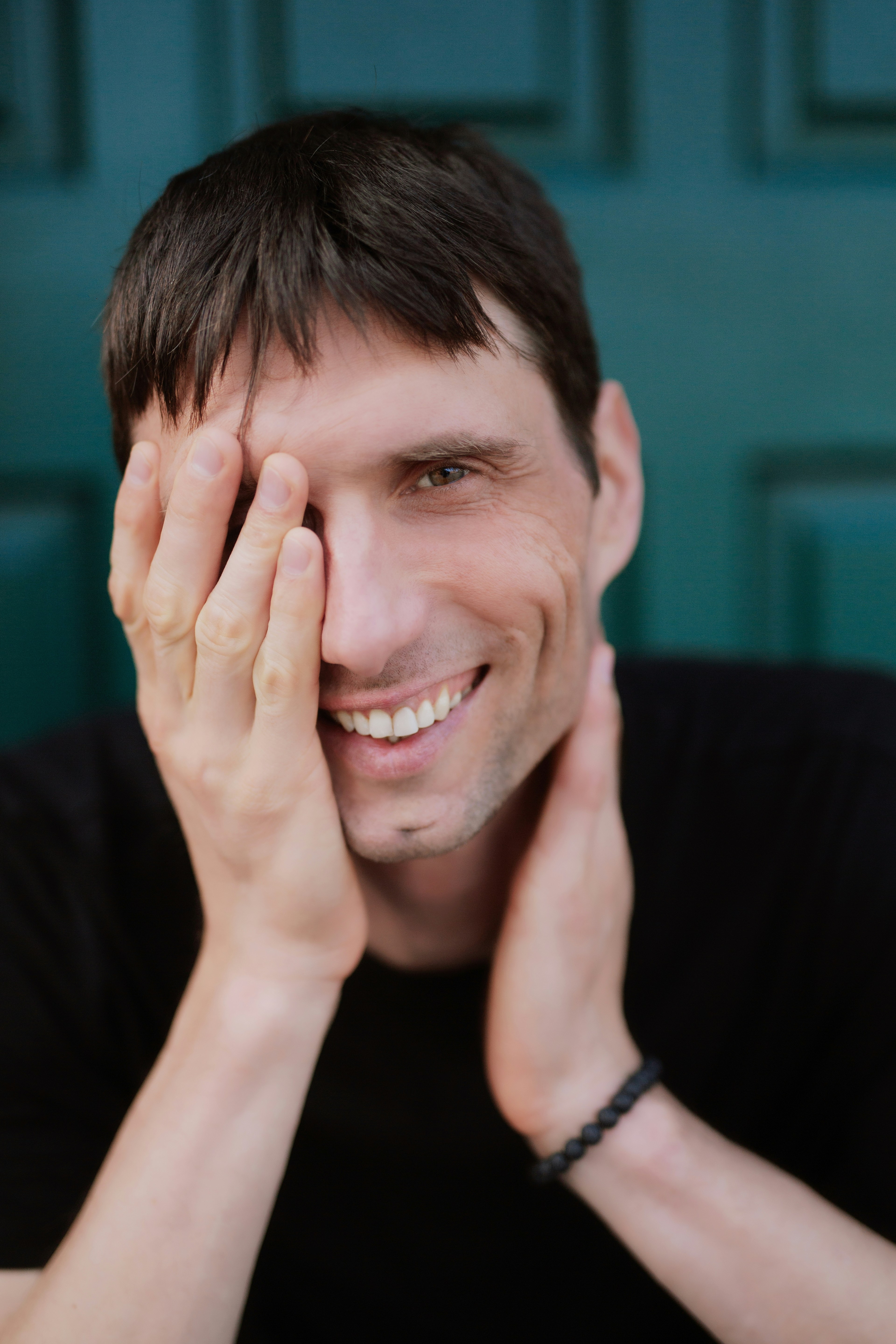 Man with hand over eye smiling photo – Free Street photography Image on ...