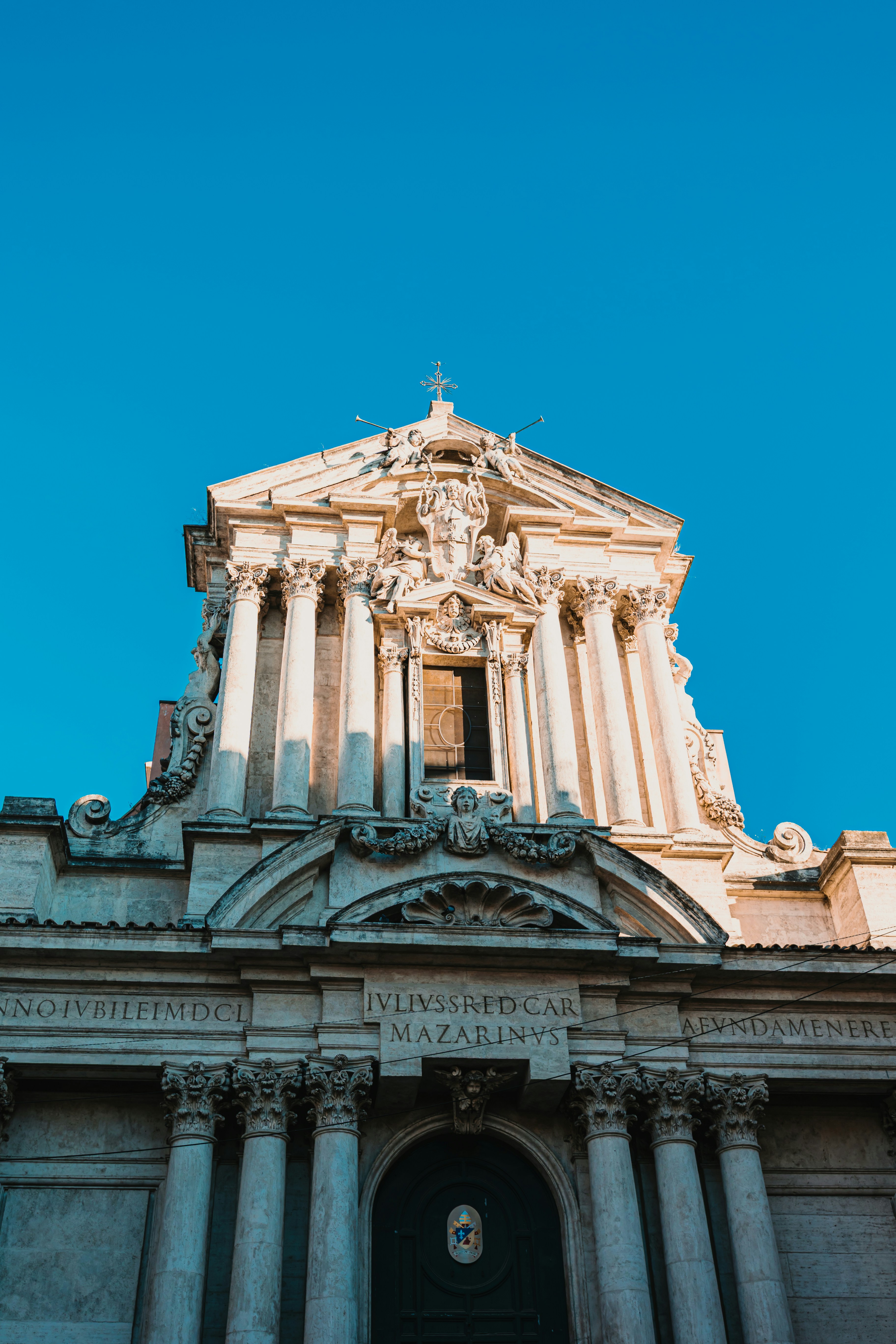 Sun-Soaked Pediment: A Marble Facade Reaching Toward the Blue