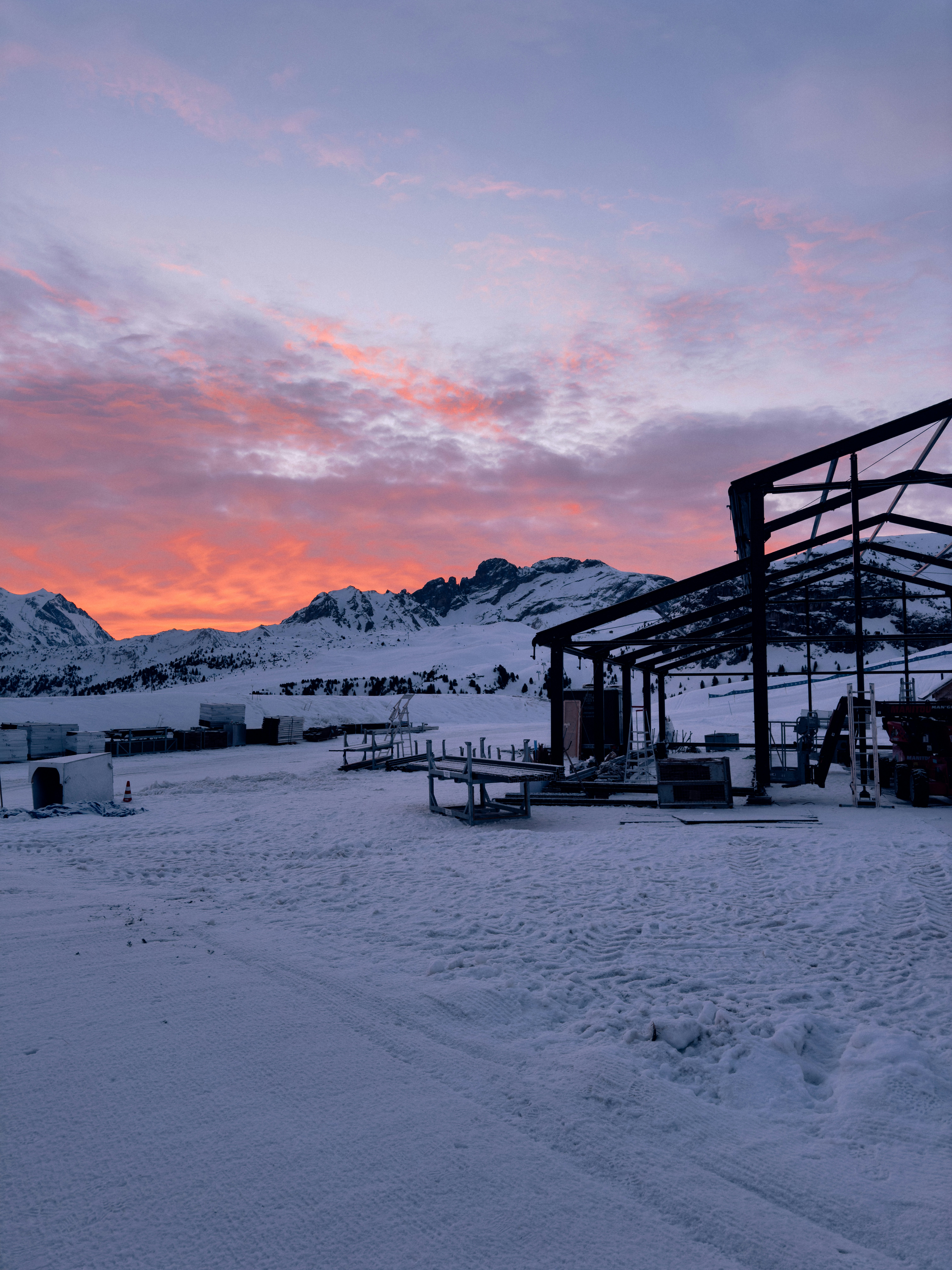 Crimson Horizon Over a Snowbound Ridge and a Skeletal Shed
