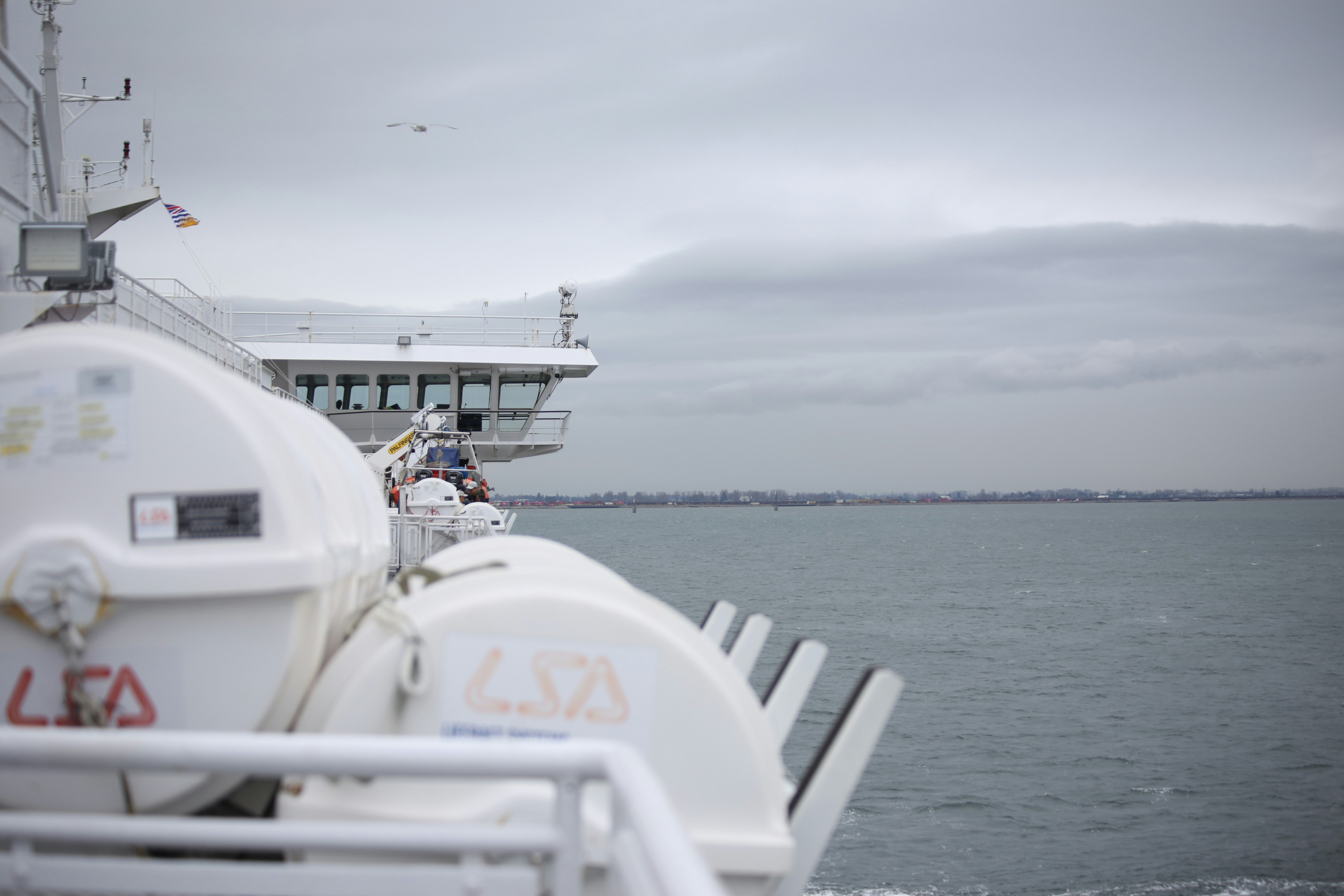 Lifeboat Foredeck: Quiet Linearity Against a Distant, Overcast Horizon