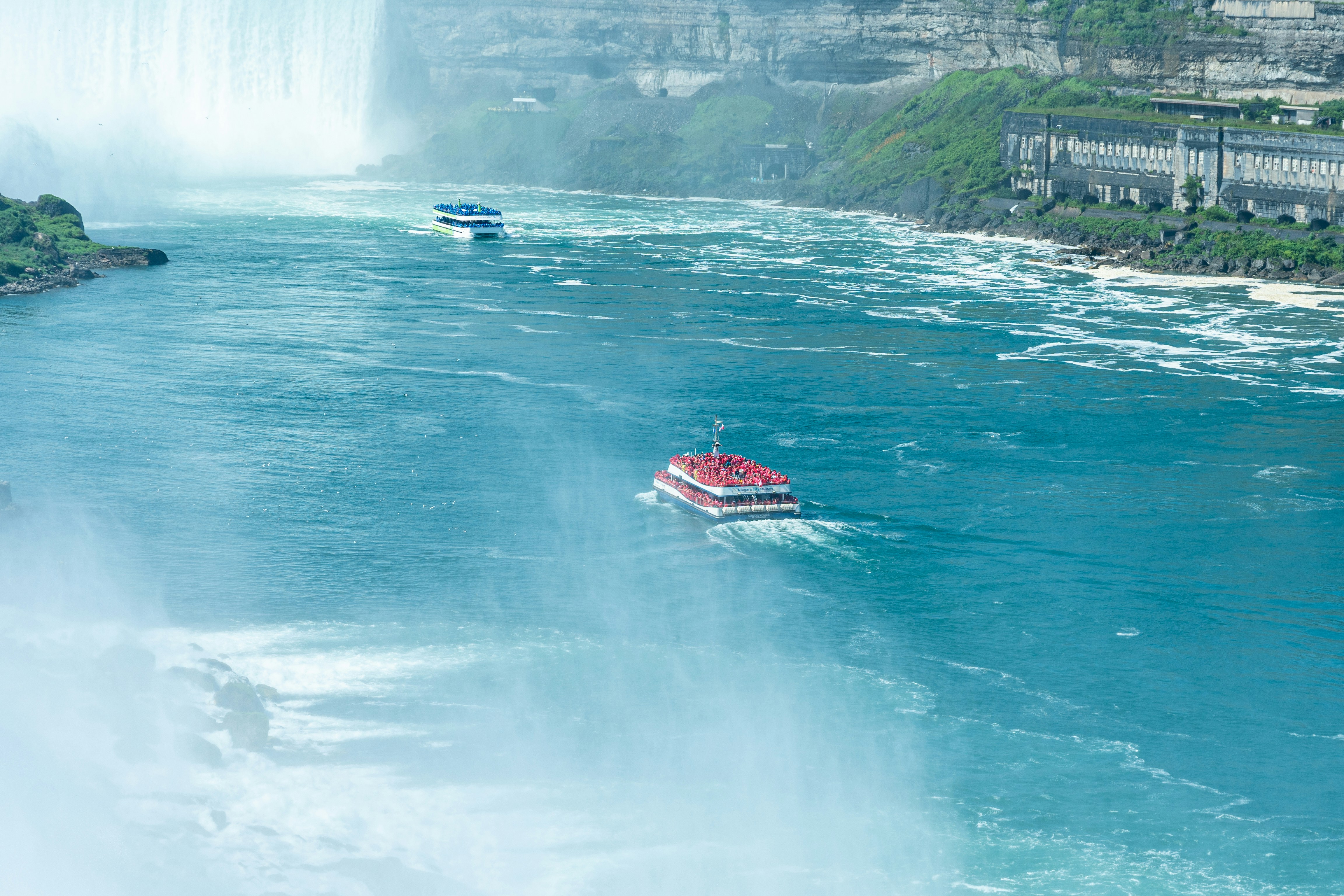 Crimson Tour Boat Cuts Through the Mist Beneath the Falls