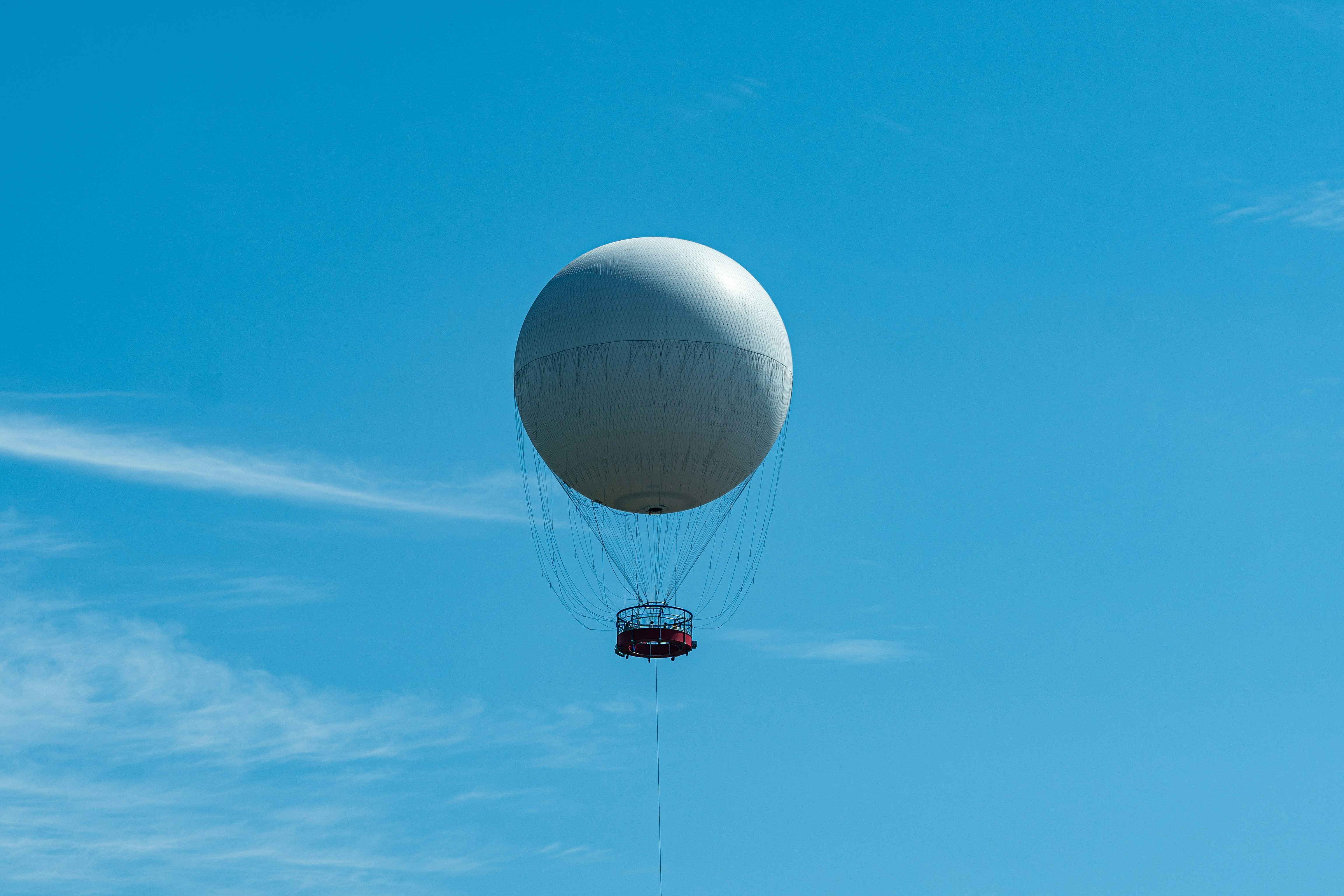 Drifting White Sphere Under a Cerulean Sky