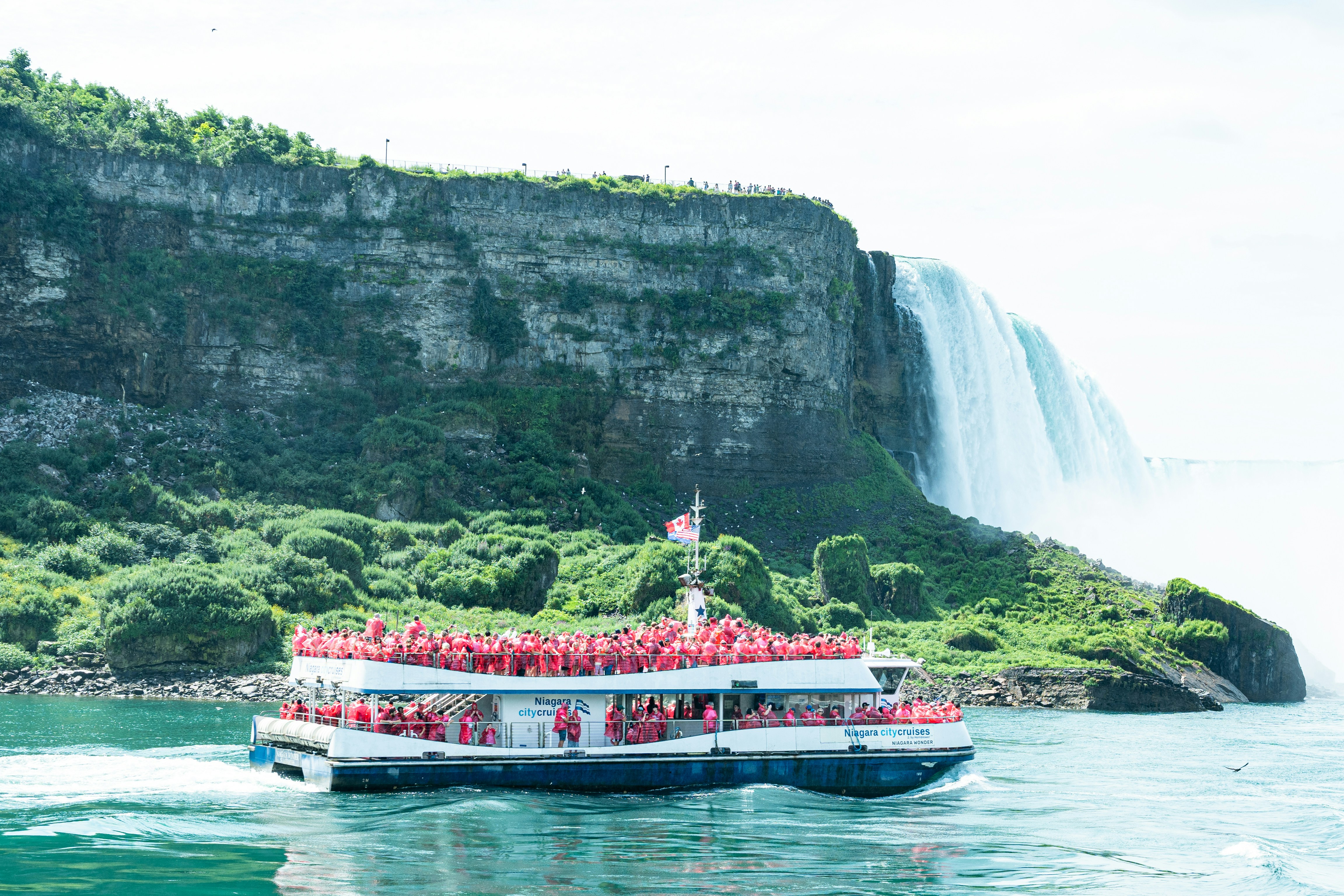 Riverfront Tour Boat Amid Niagara-Style Falls Backdrop
