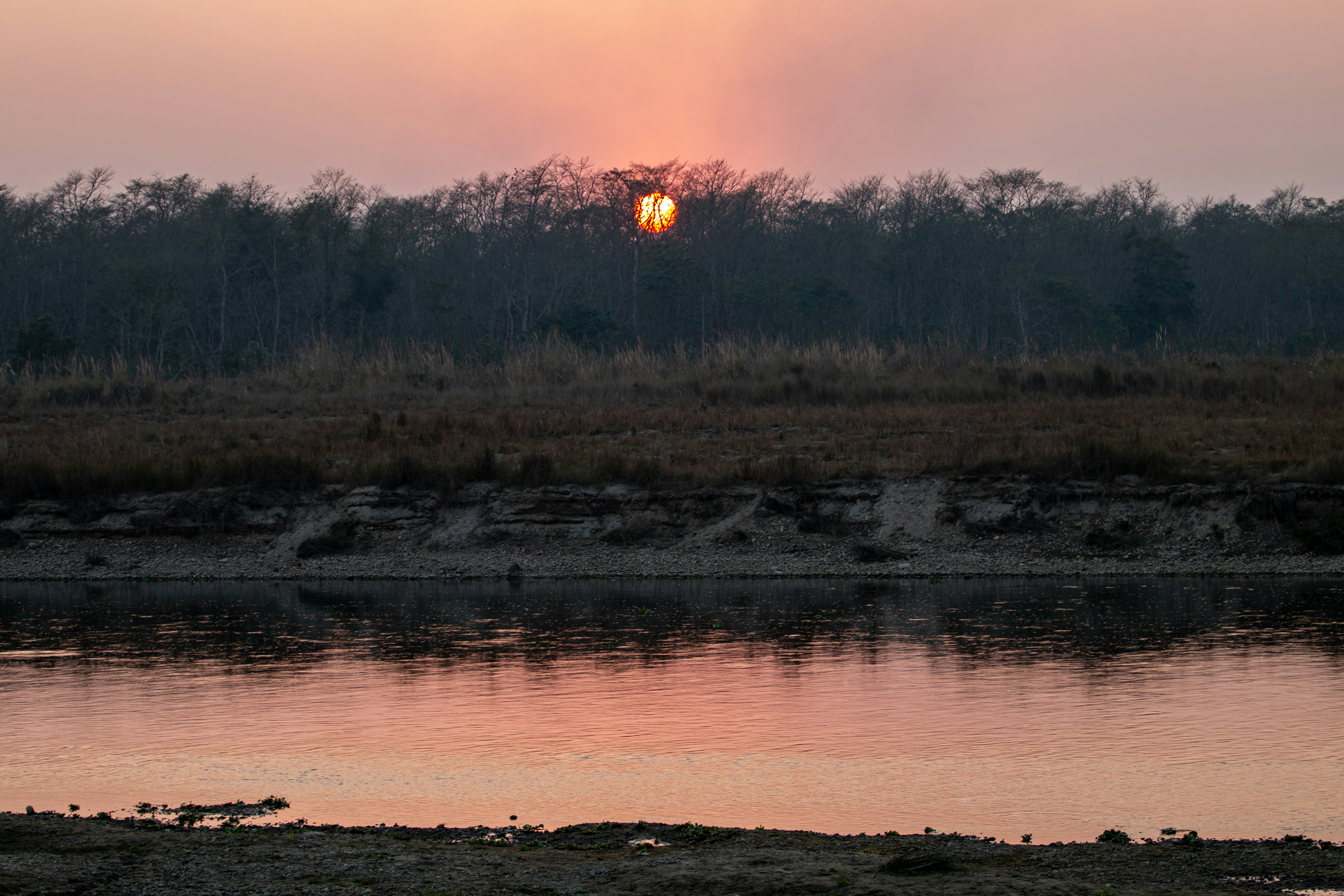 Sunset Glow Over Chitwan Jungle Reflected on the Quiet River