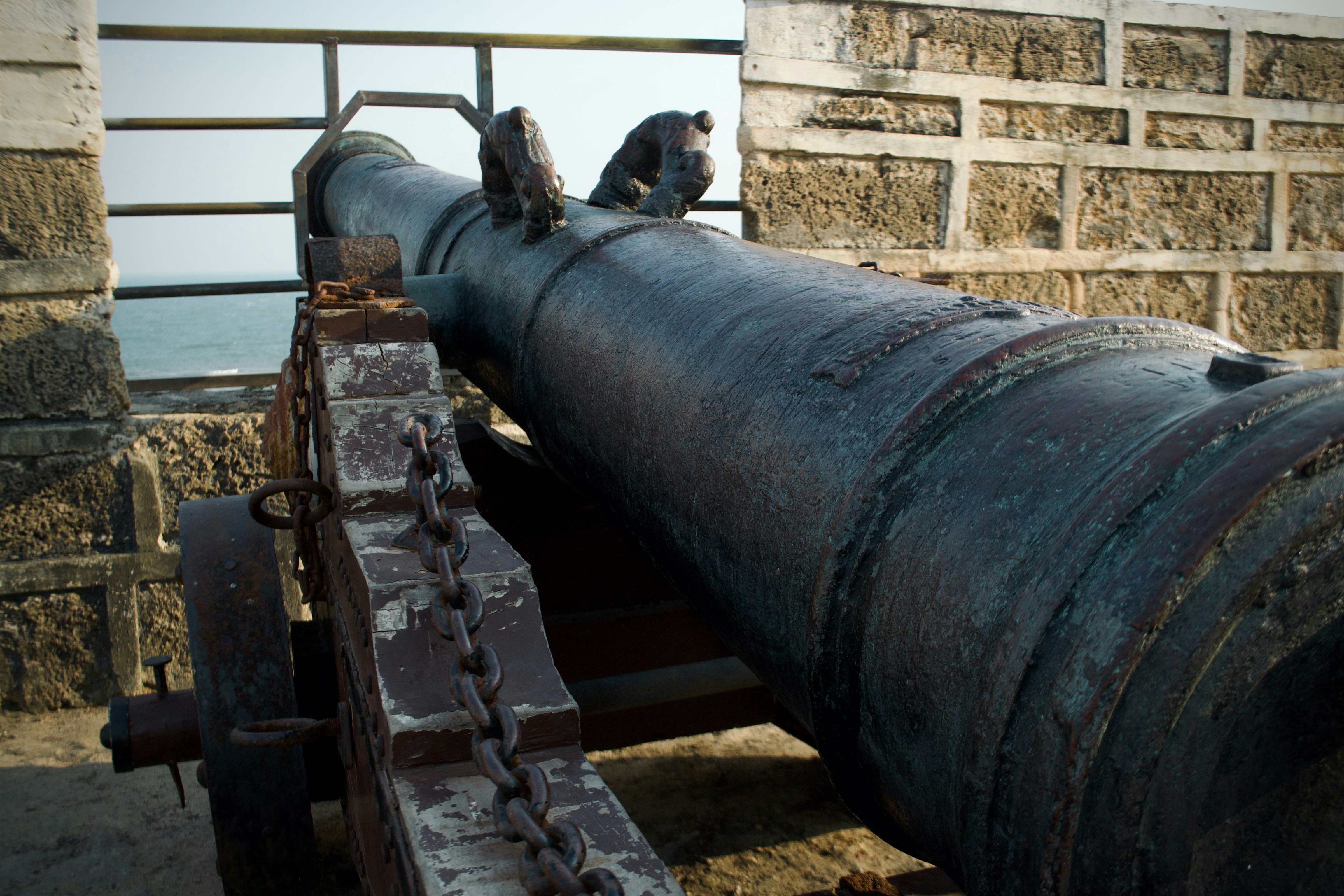 Ancient Gun, Sea Breeze: A Weathered Cannon Guards the Cliffside
