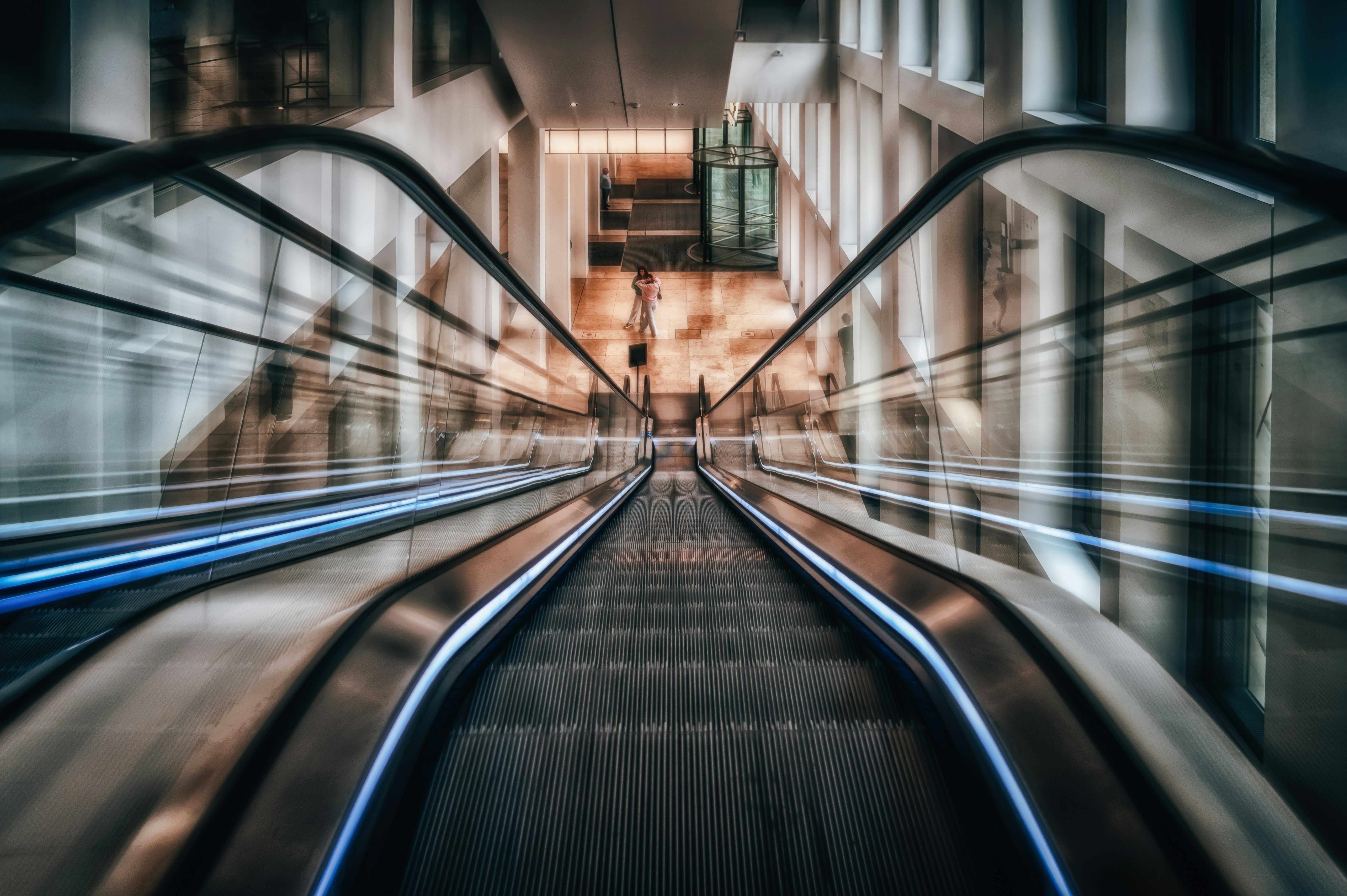 Convergence at the Transit Staircase: A Figure Anchors the Escalator's Vanishing Point
