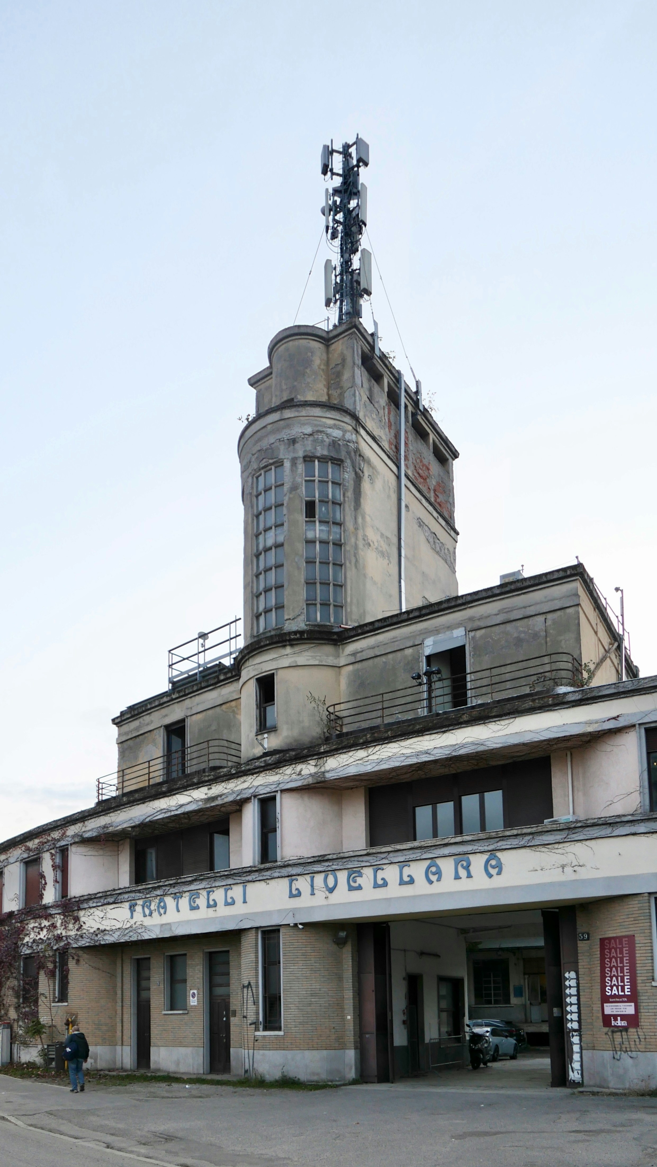 Crowned by Antenna: The Weathered Hotel Tower