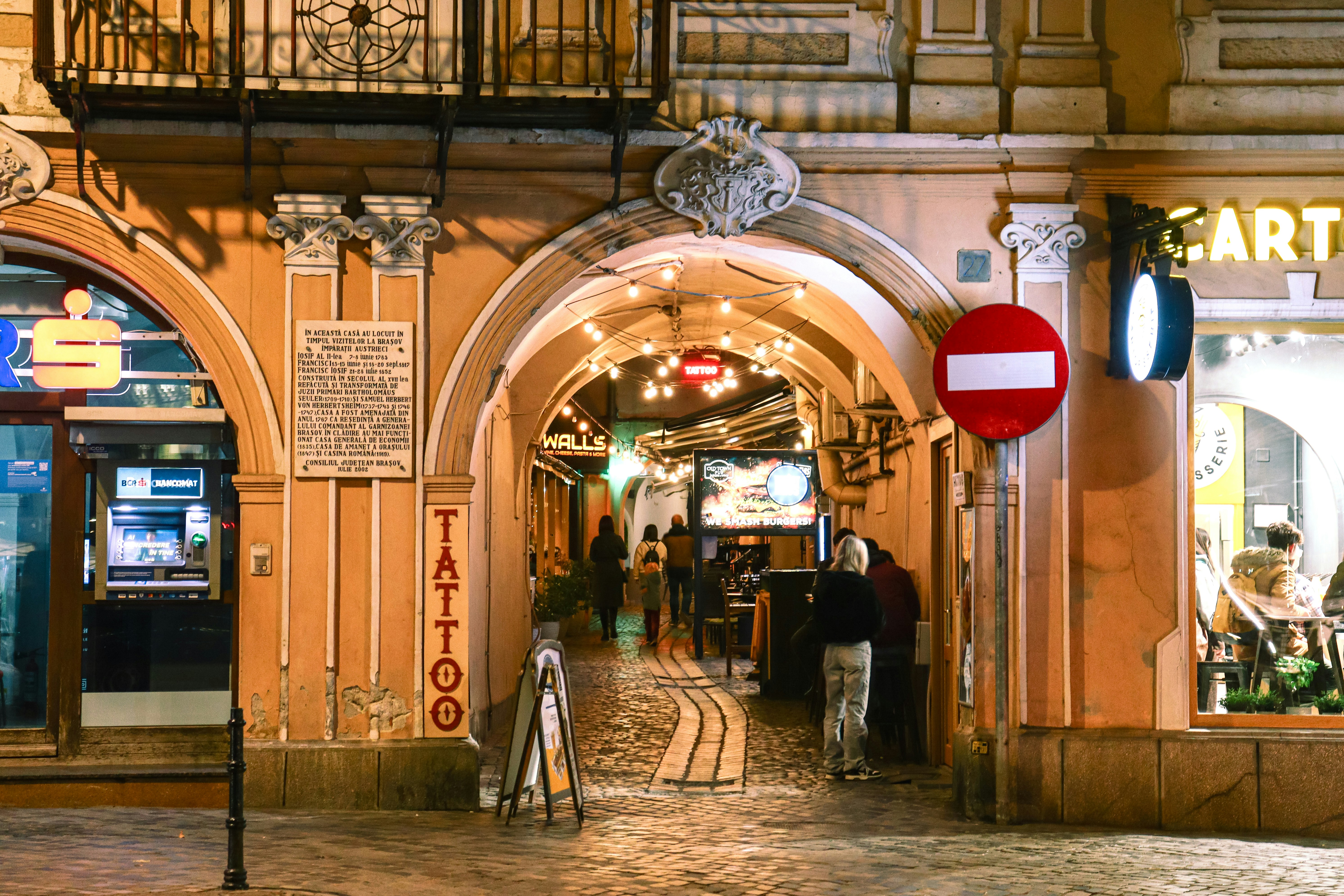 Under the Archway of Light: Cobblestone Corridor into the Evening Arcade