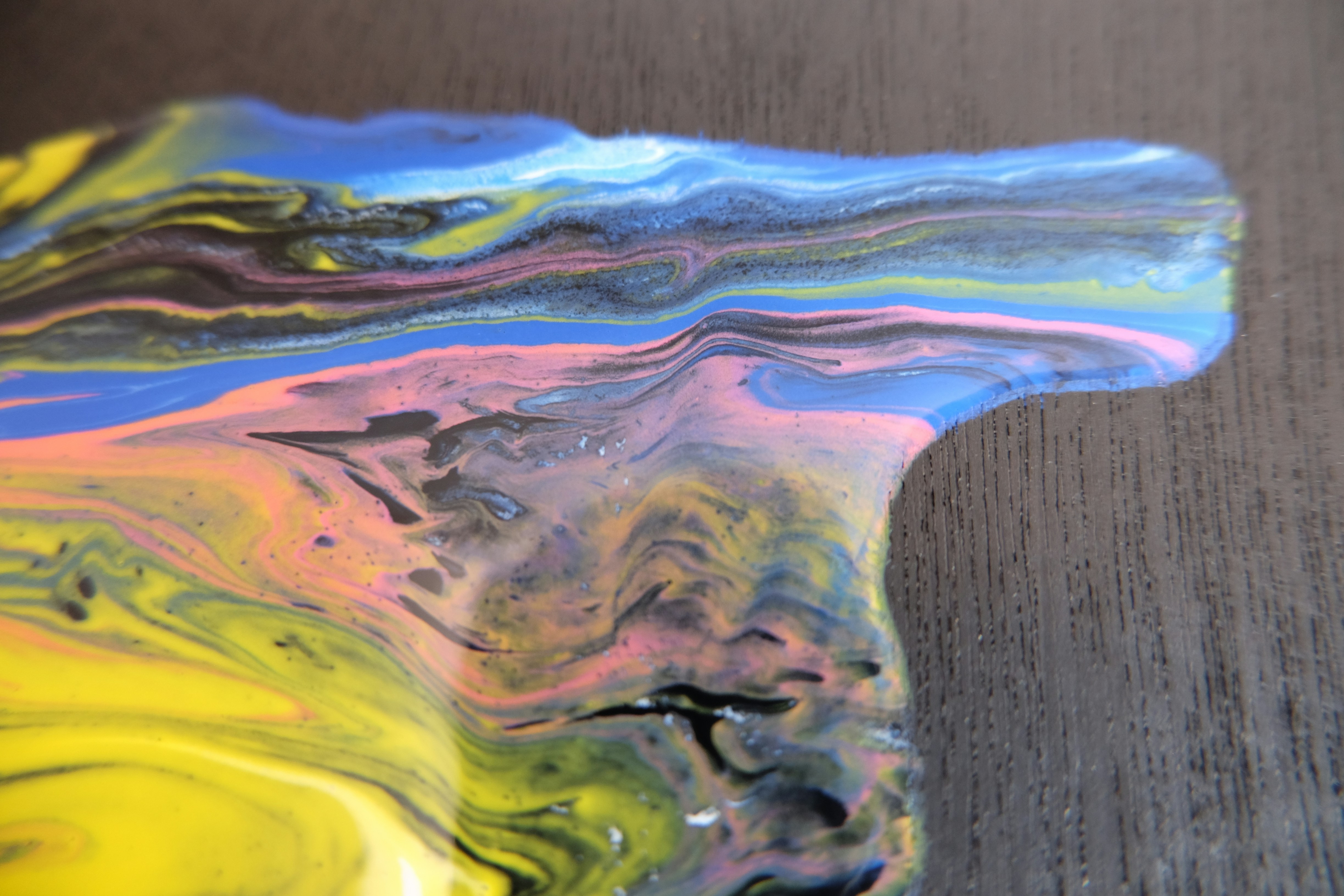 Edge of a Melted Palette: Neon Swirls Along Wood