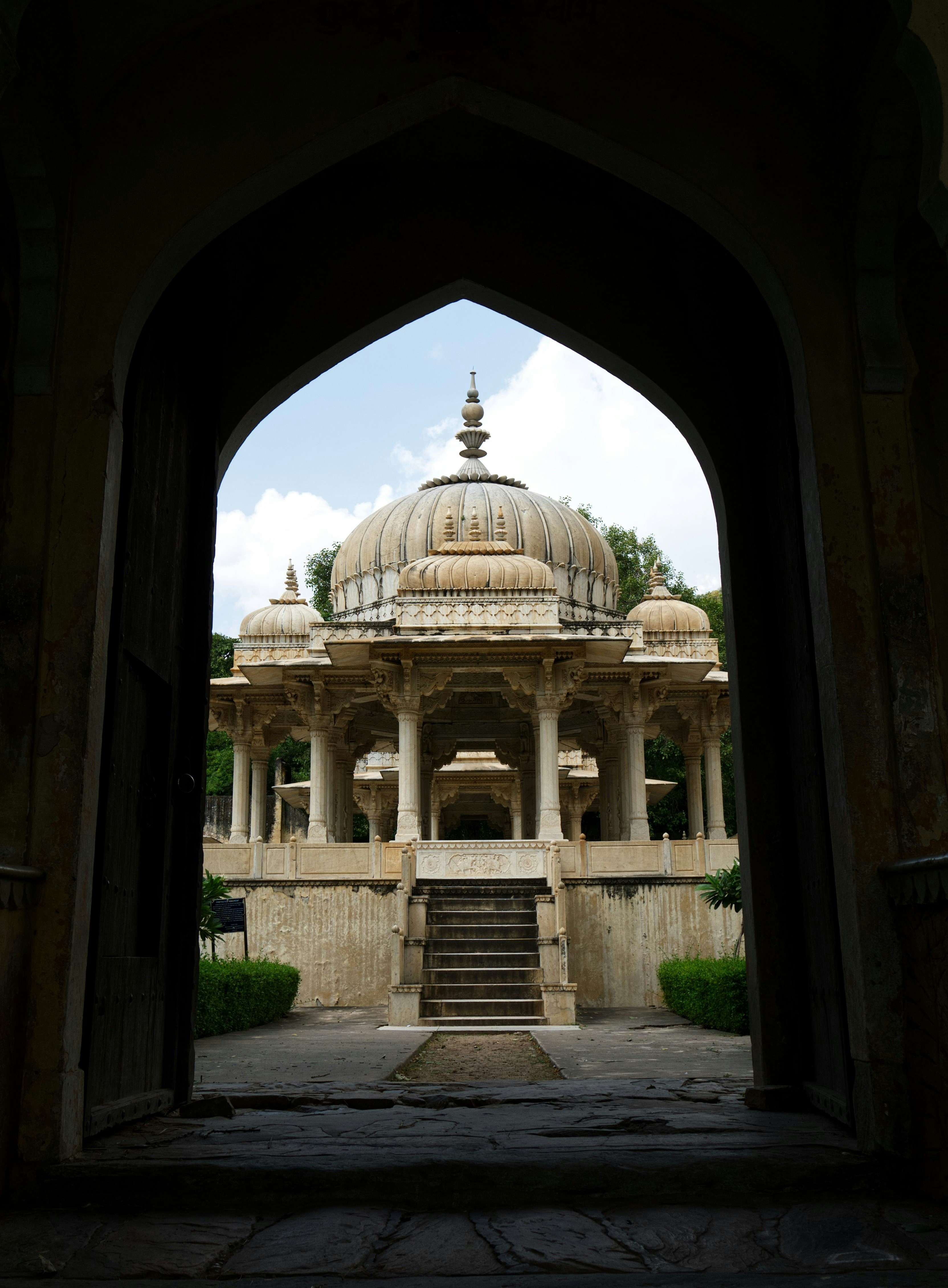 Archway to Dome: a sunlit pavilion framed within ancient stone