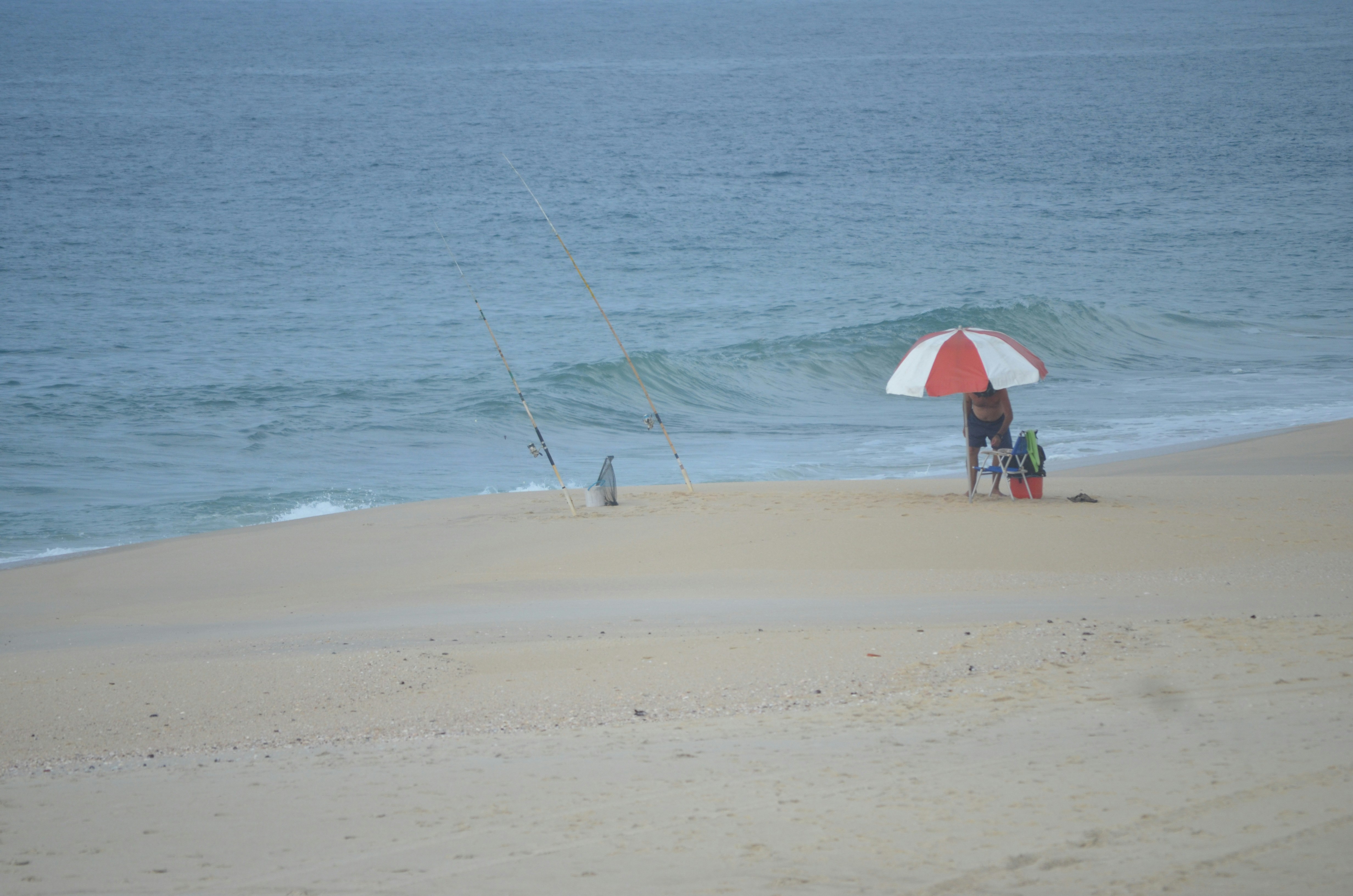 Red-White Umbrella at the Quiet Beach Edge