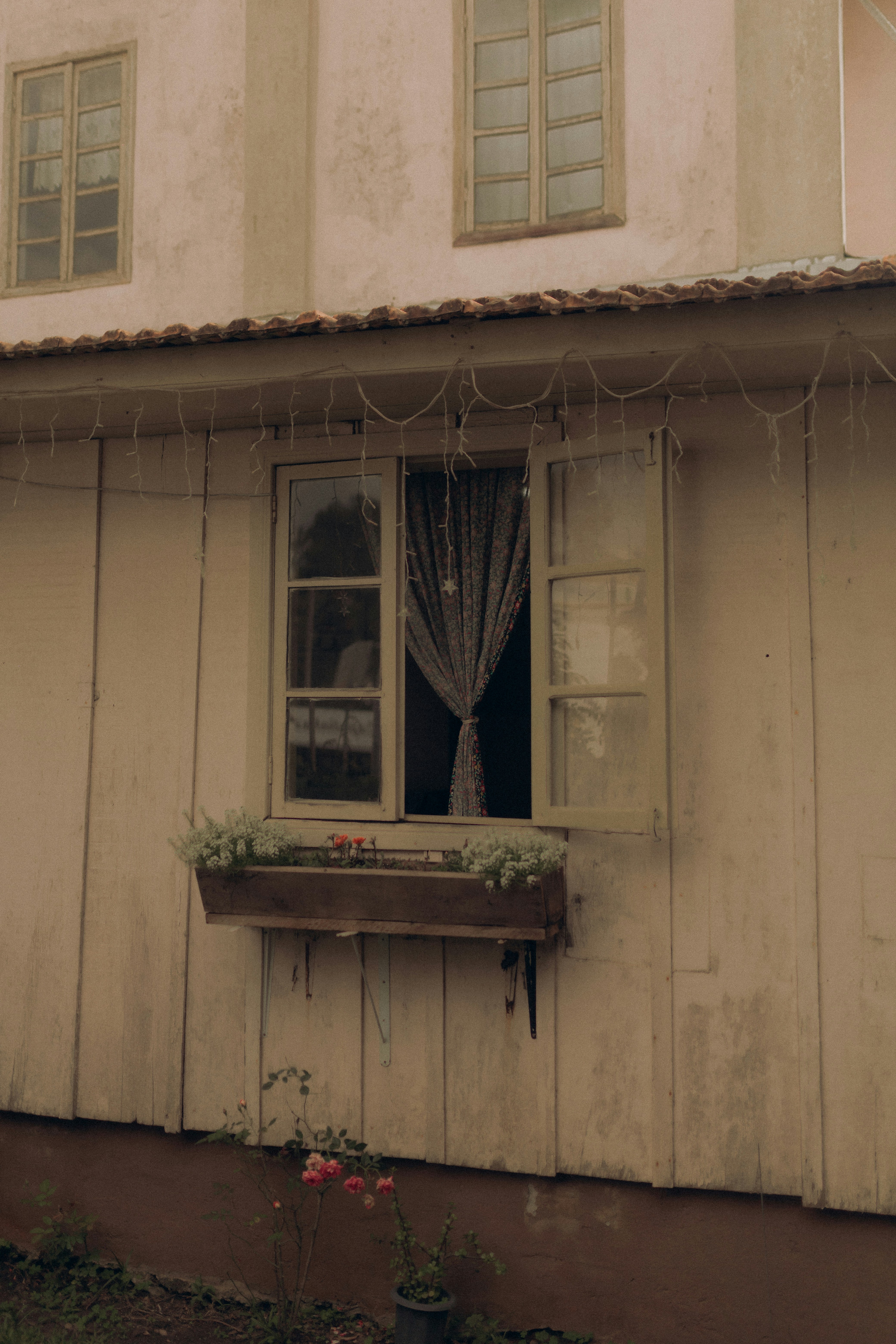 Open-Window Portrait on a Weathered Facade