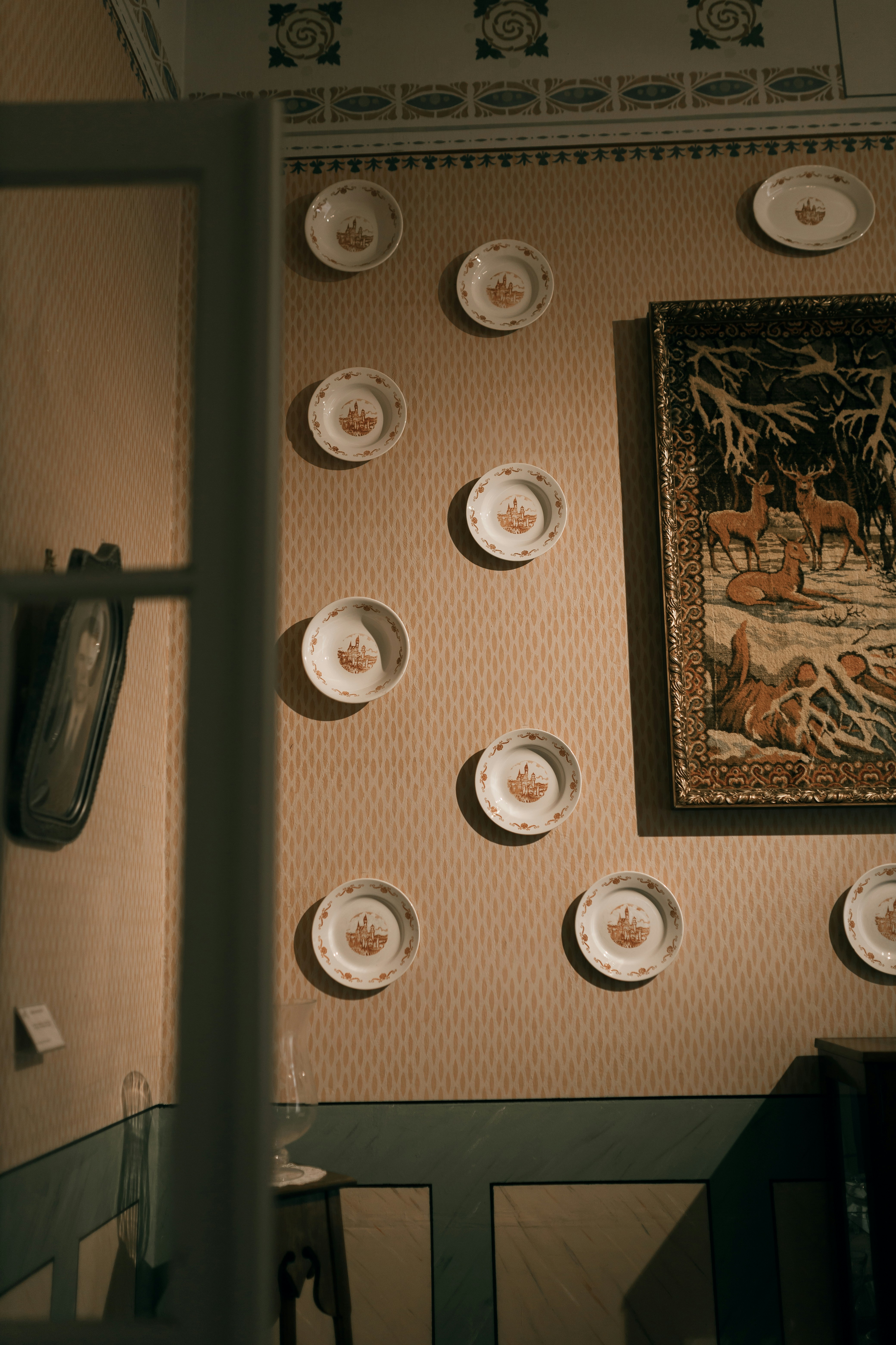 Porcelain on the Wall: A Quiet Gallery of Plates and Tapestry