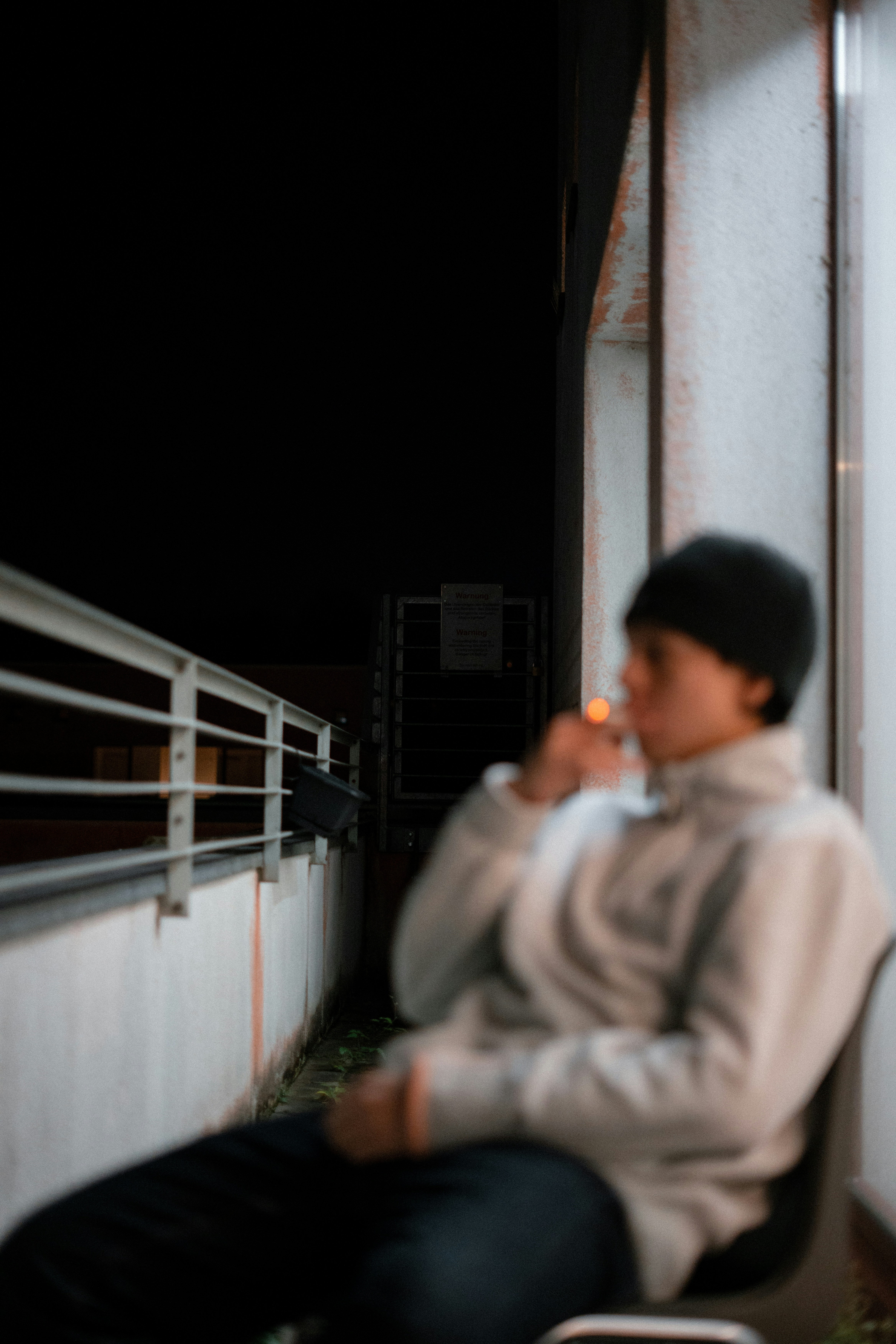 Midnight Balcony Smoke: A Quiet Moment in Soft Focus