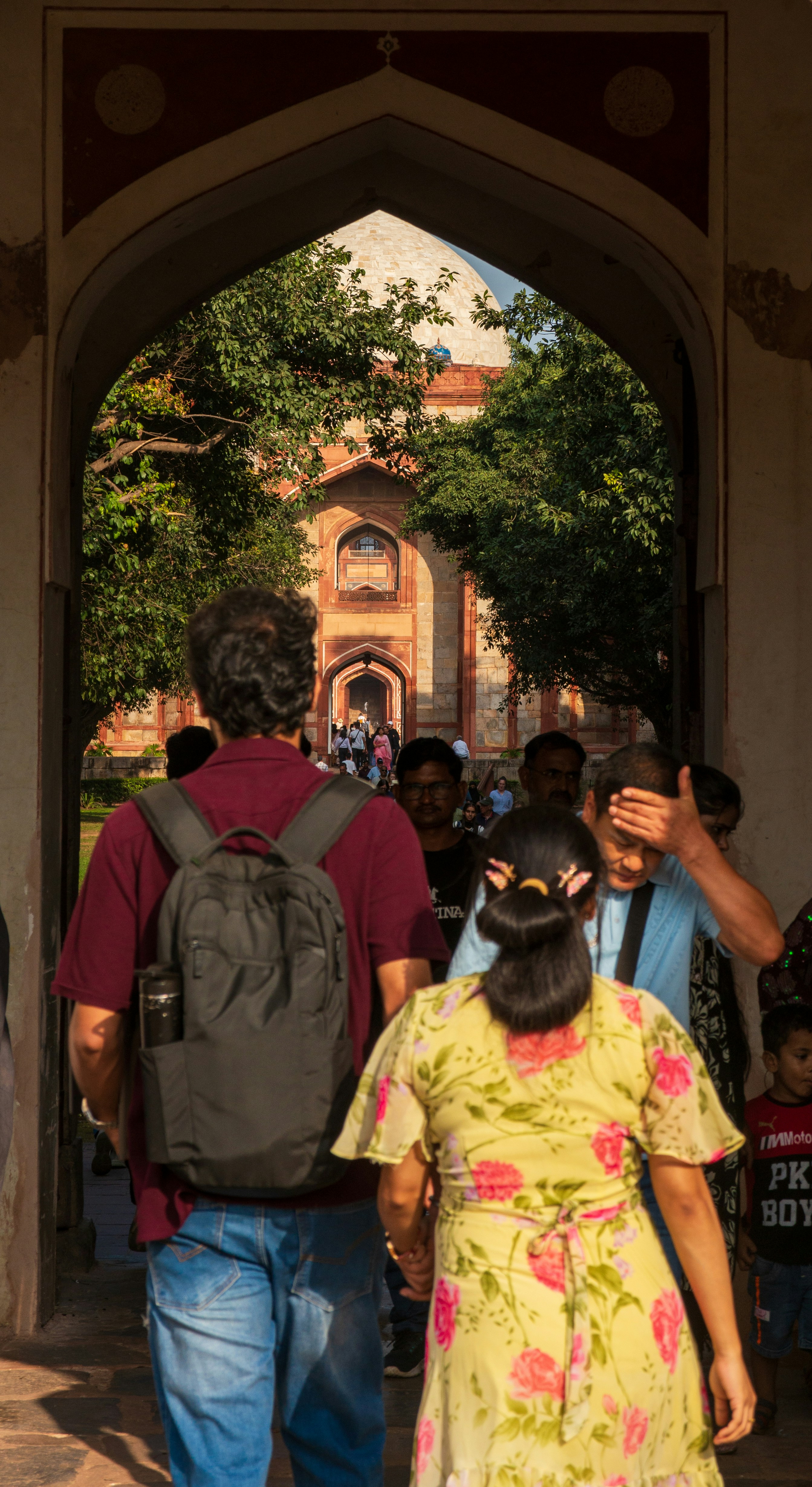 Archway to the Amber Gate: A Sunlit Corridor of Faces