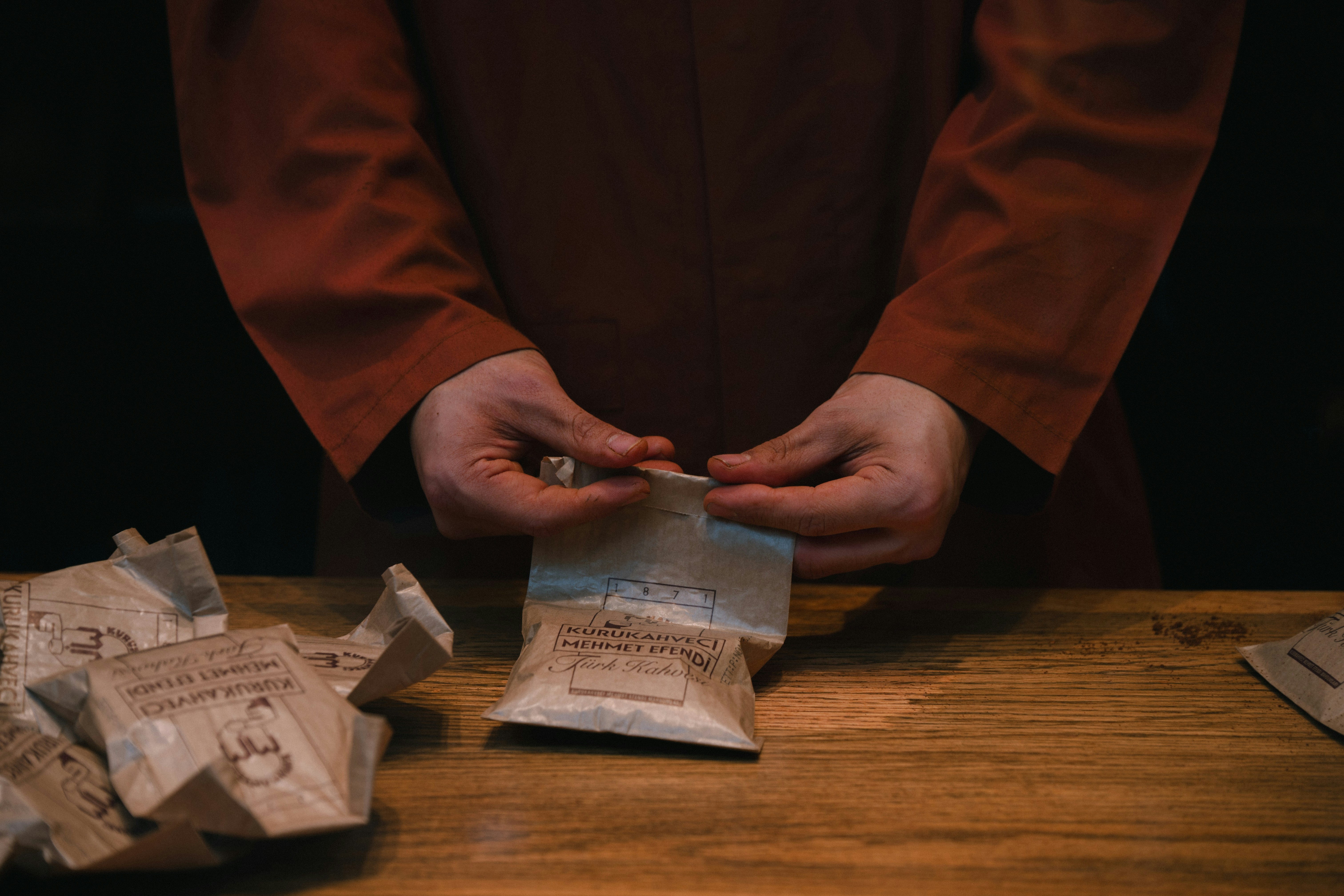 The Quiet Fold: Hands shaping a sachet on a wooden counter