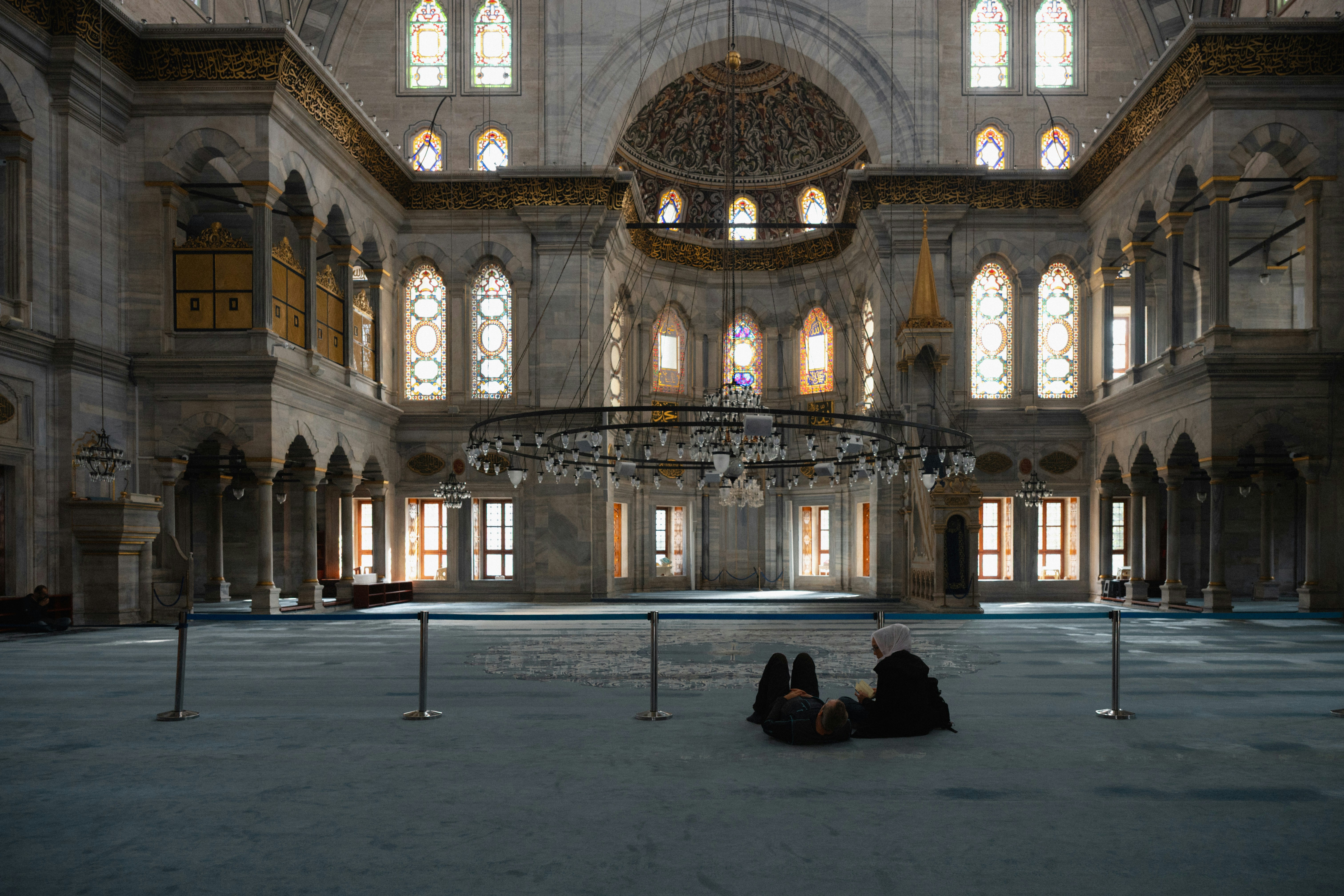 Two Figures, One Quiet Moment in a Grand Hall