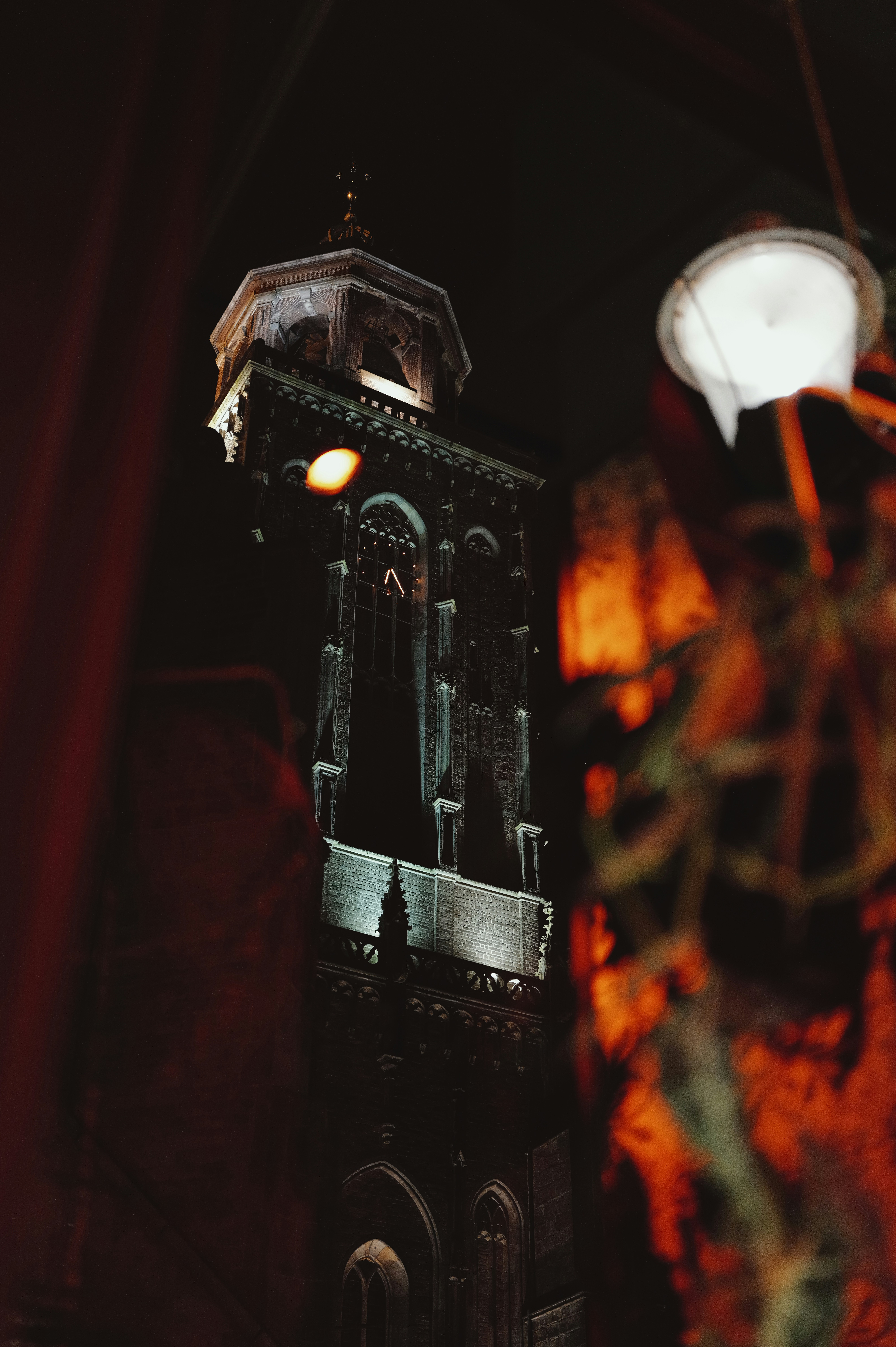 Gothic tower illuminated at night with warm lights